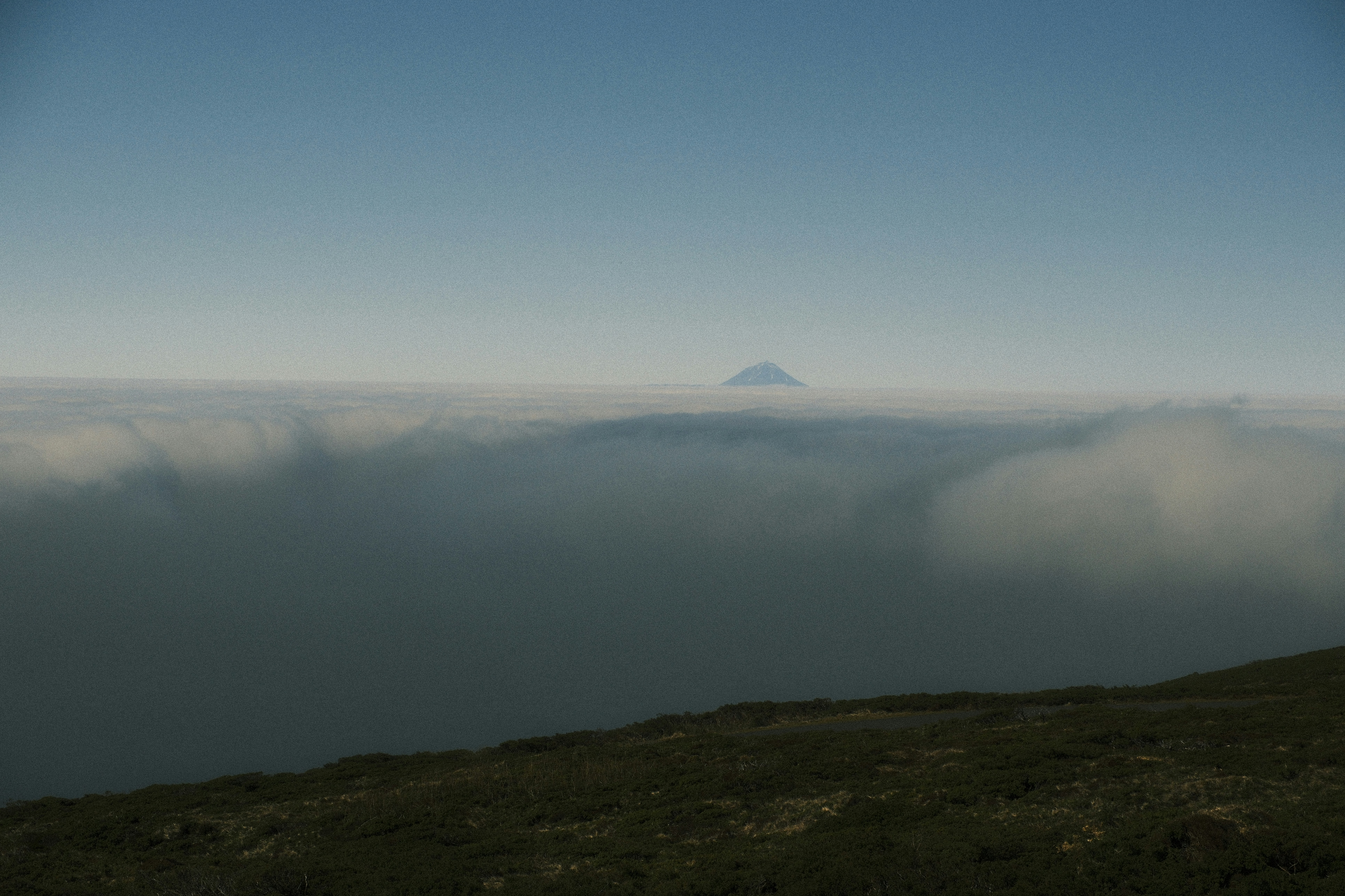 Isolated Peak Above a Sea of Clouds at Dawn