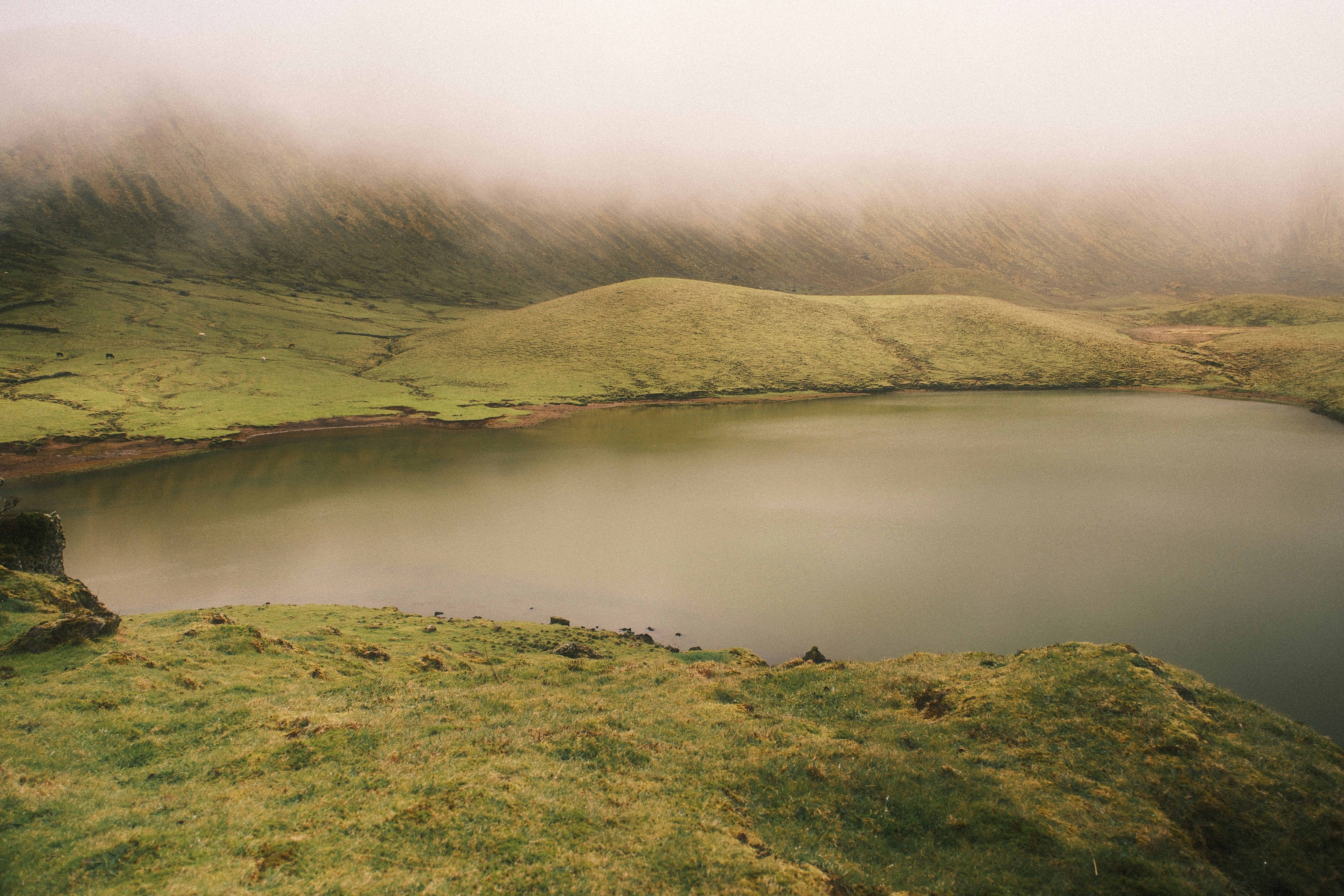 Mist-Laced Tarn Between Sloping, Fallow Hills