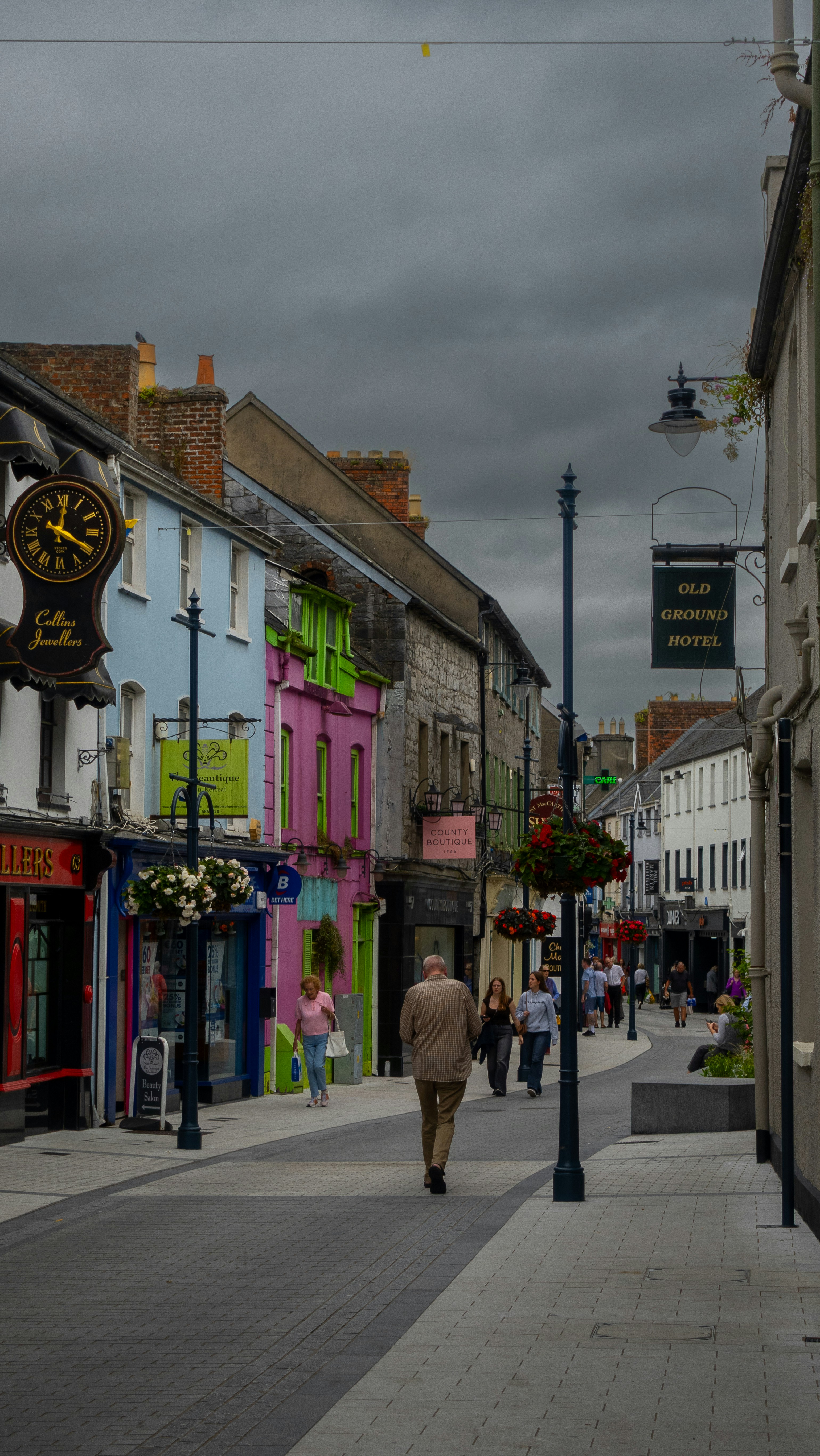 Colorful Main Street: People, Shade, and a Timeless Clock