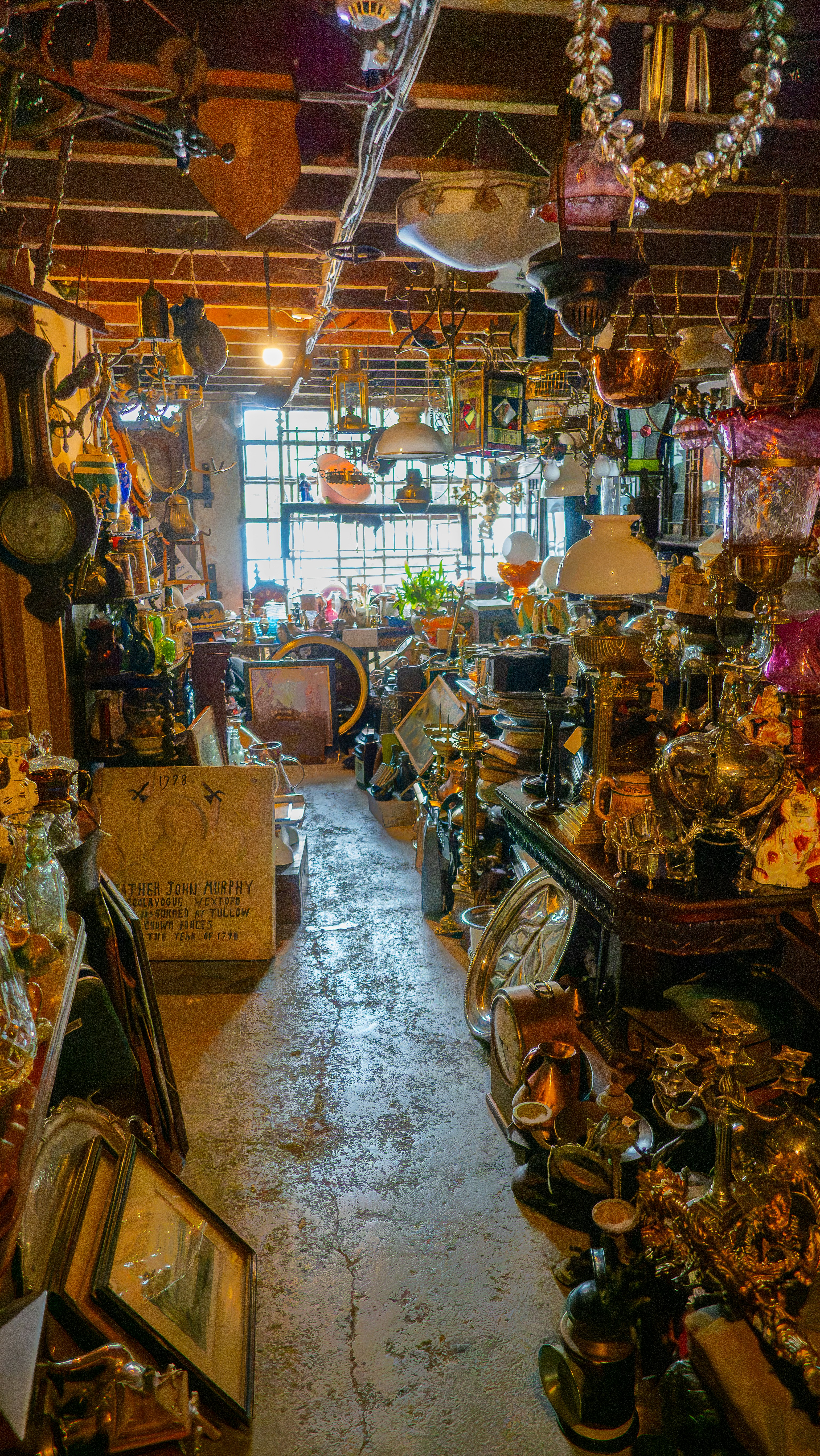 Crammed Treasure Trove: An Antique Shop Alley Packed with Gleaming Curios
