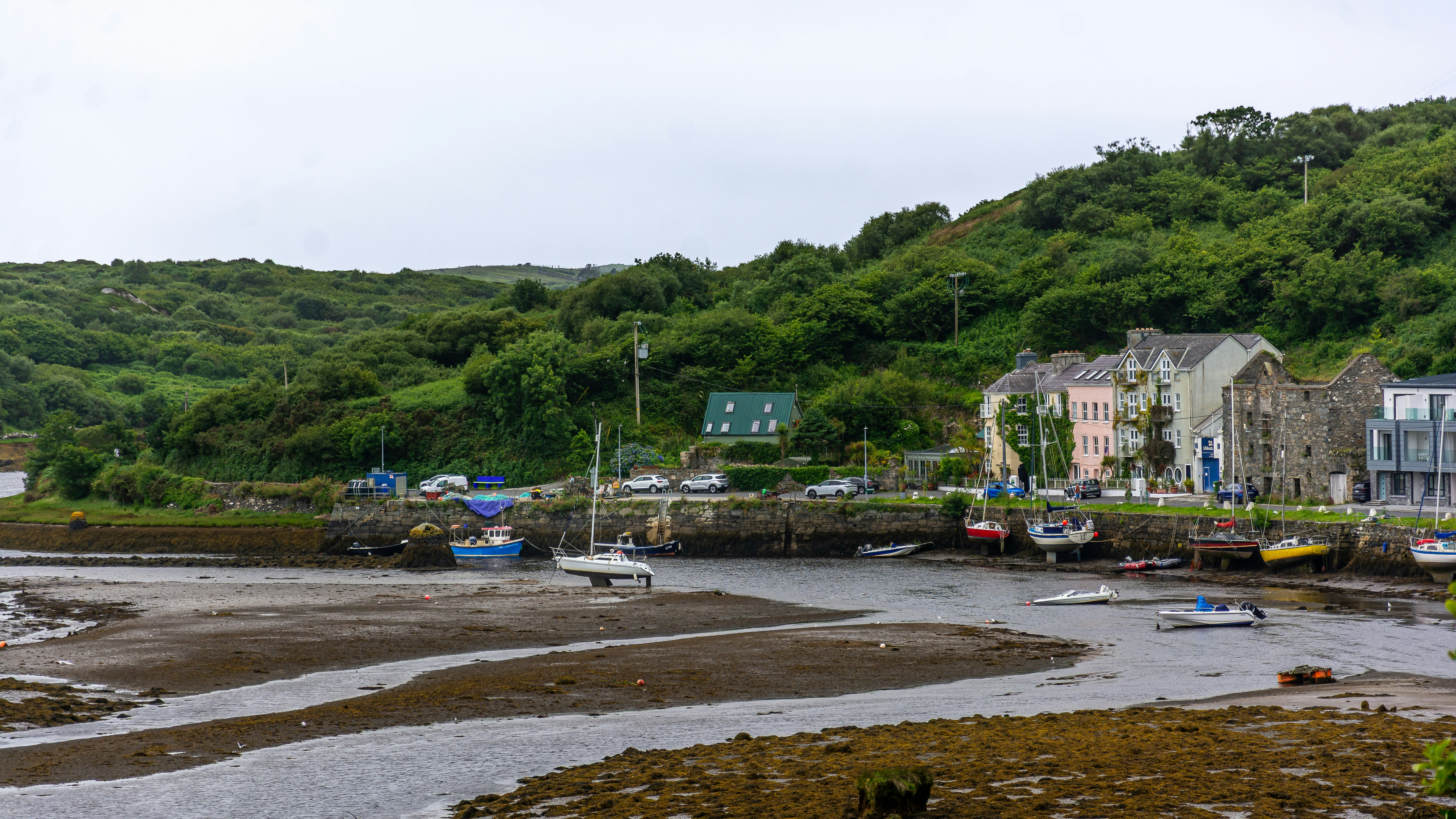 Harbor Pastures: Boats Rest Along a Cove as Village Homes Rise Behind