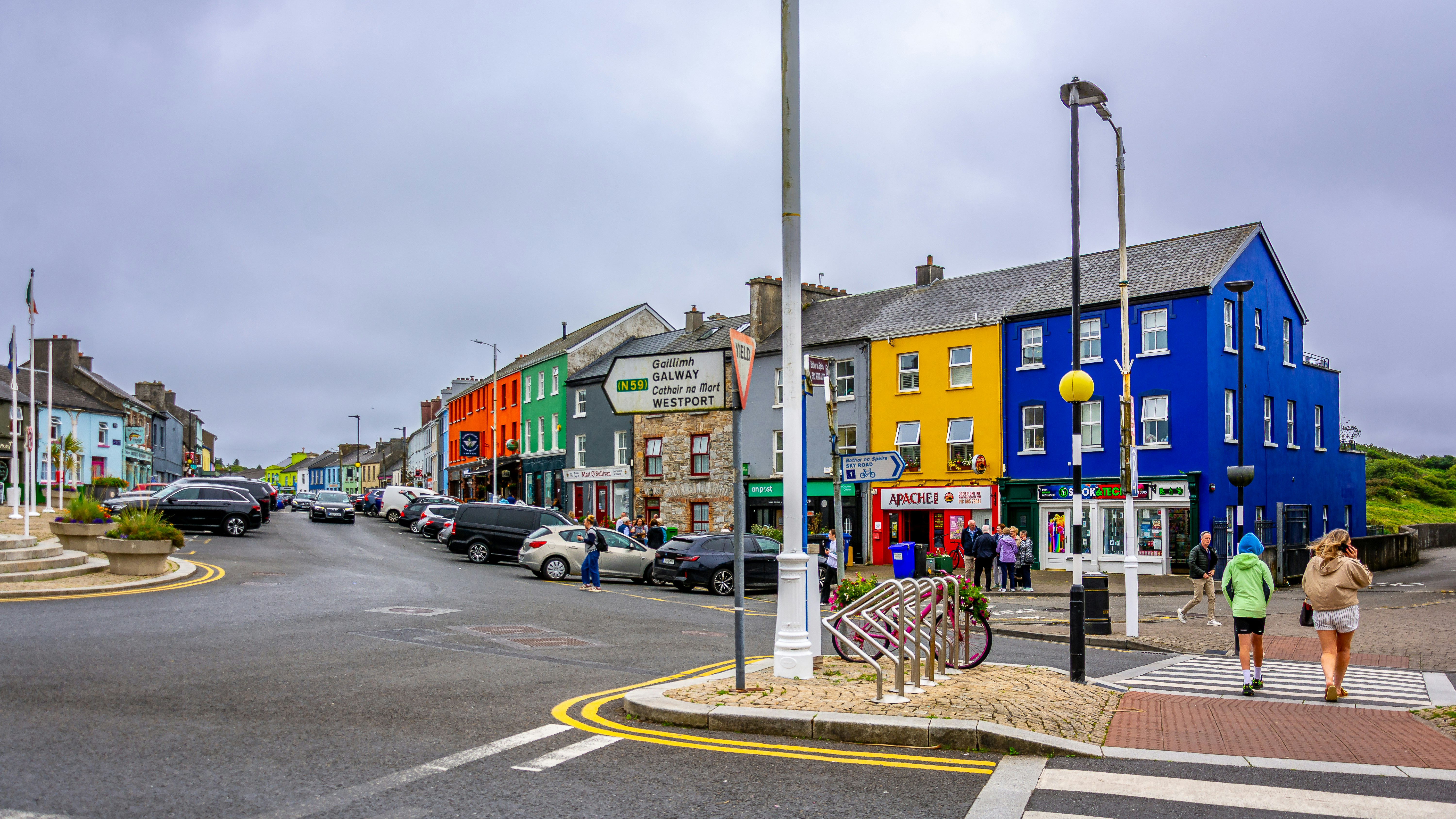 Colorful Row of Coastal Shops Framed by a Sunny Pierscape