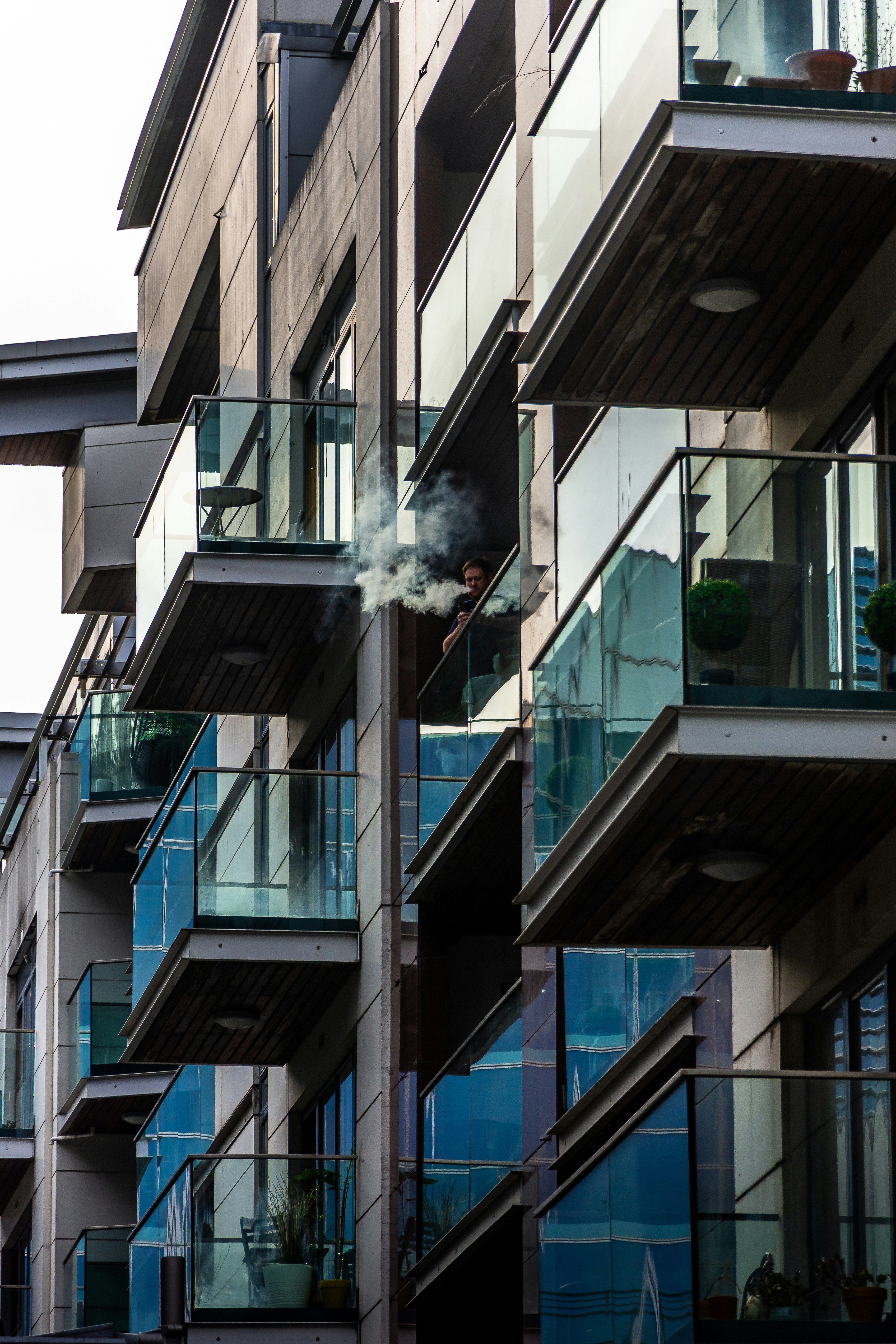 Smokestack Pause on a Glass-Clustered Highrise
