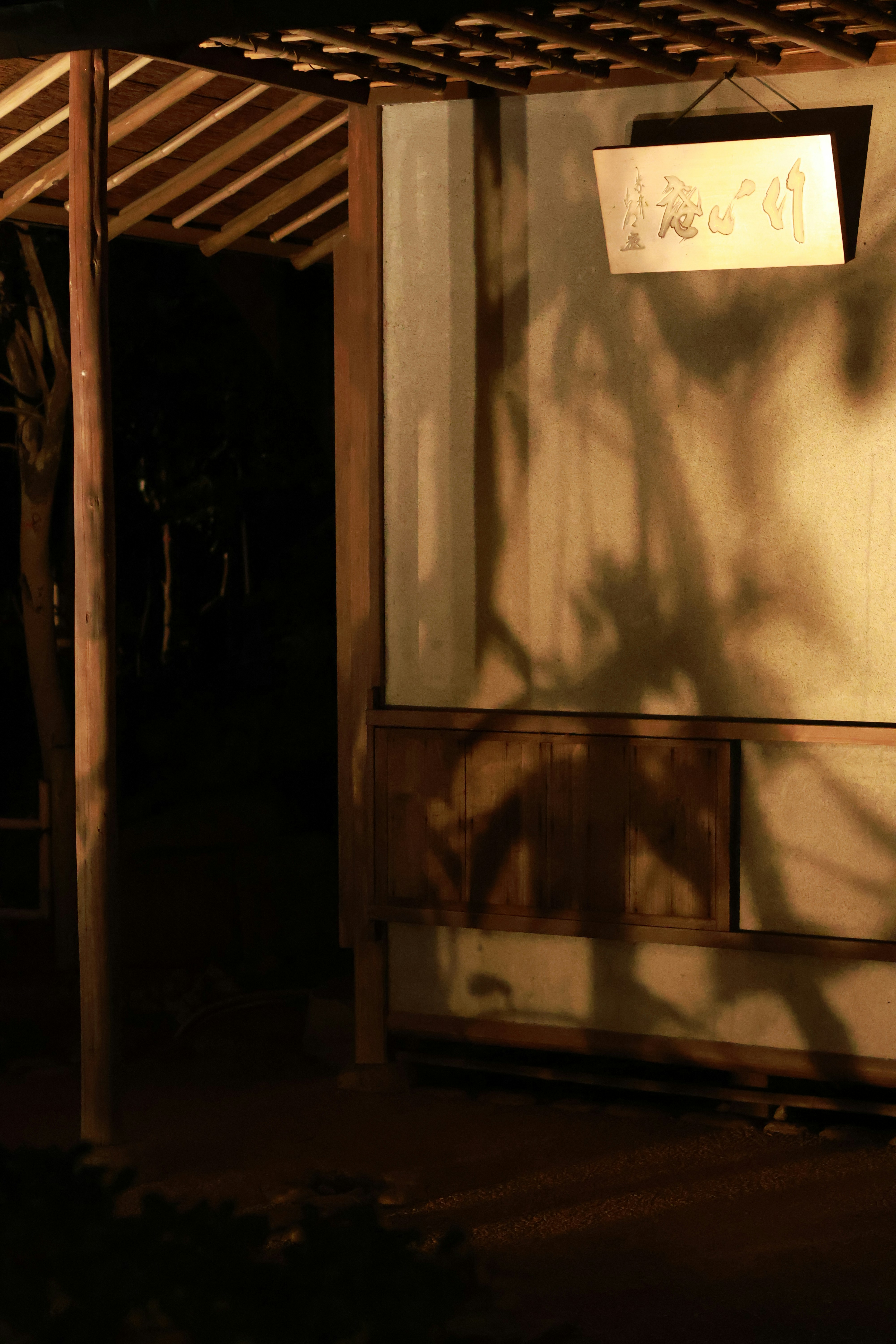 Night at the Quiet Entrance: Warm Light on a Wooden Structure