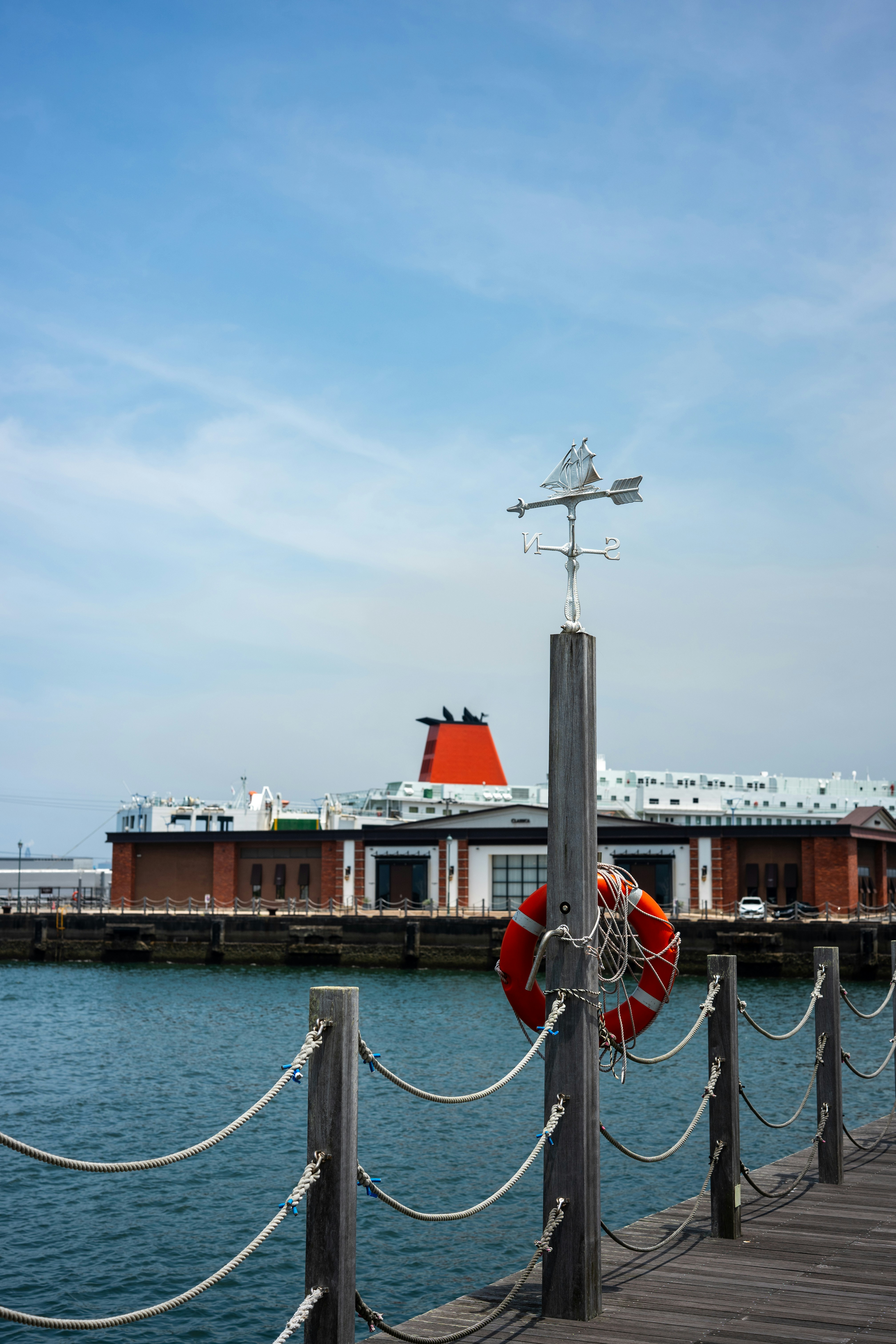 Still on the Pier: A Wind-Swept Lighthouse Post Over Quiet Water