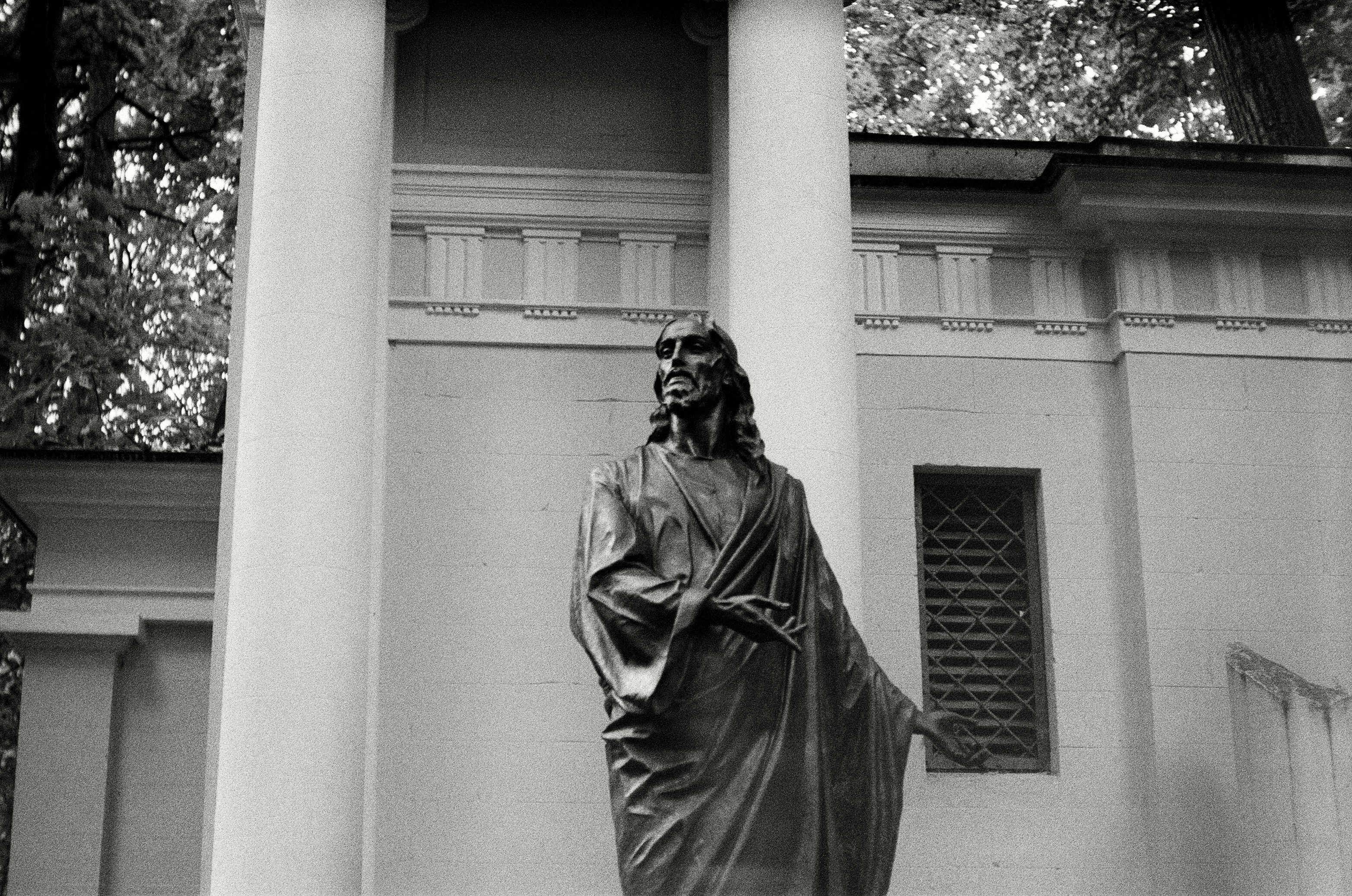 Bronze Scholar: a statue beneath classical columns