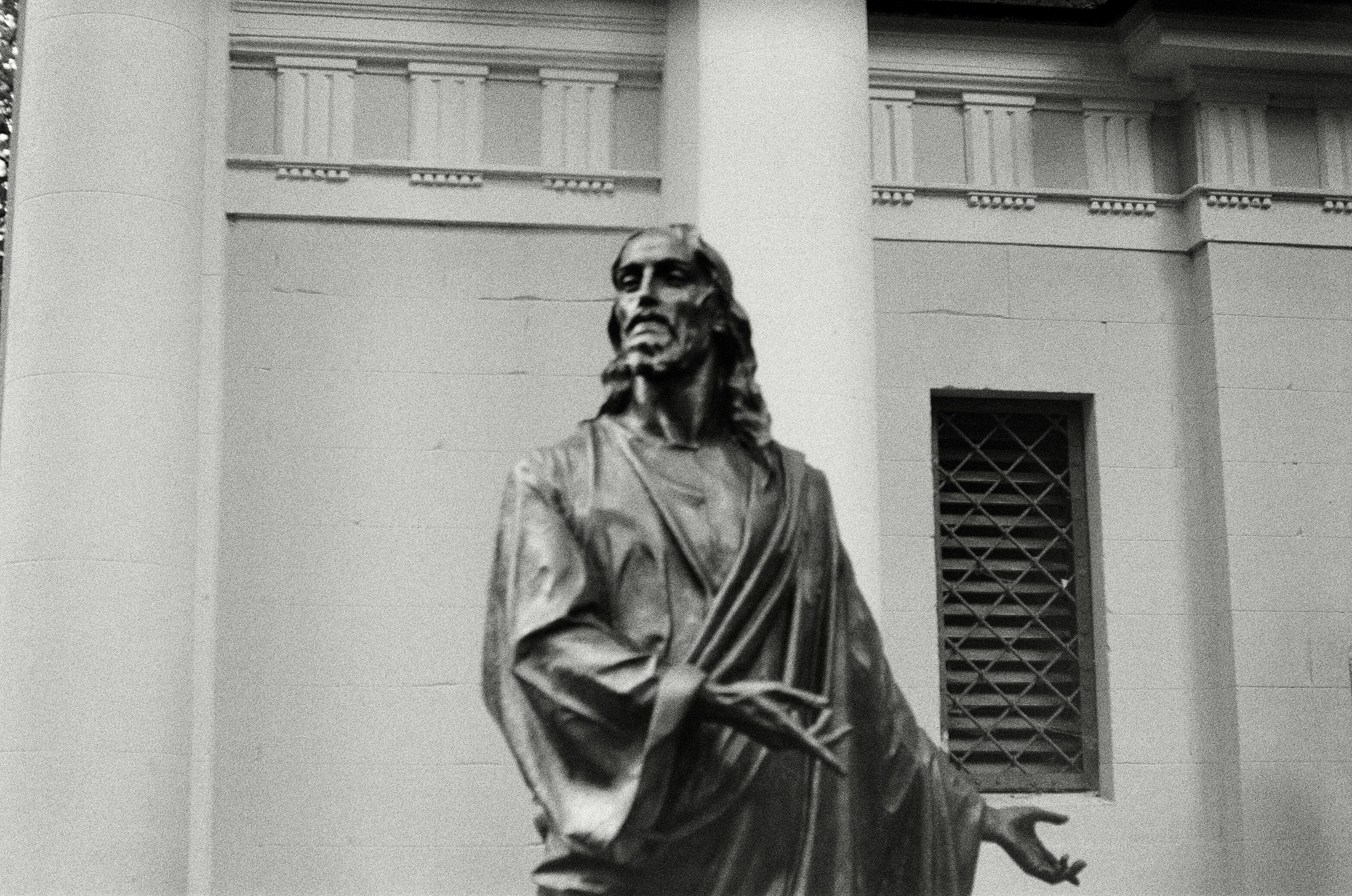 Monumental Gaze: A Stone Figure Reaching Toward the Light