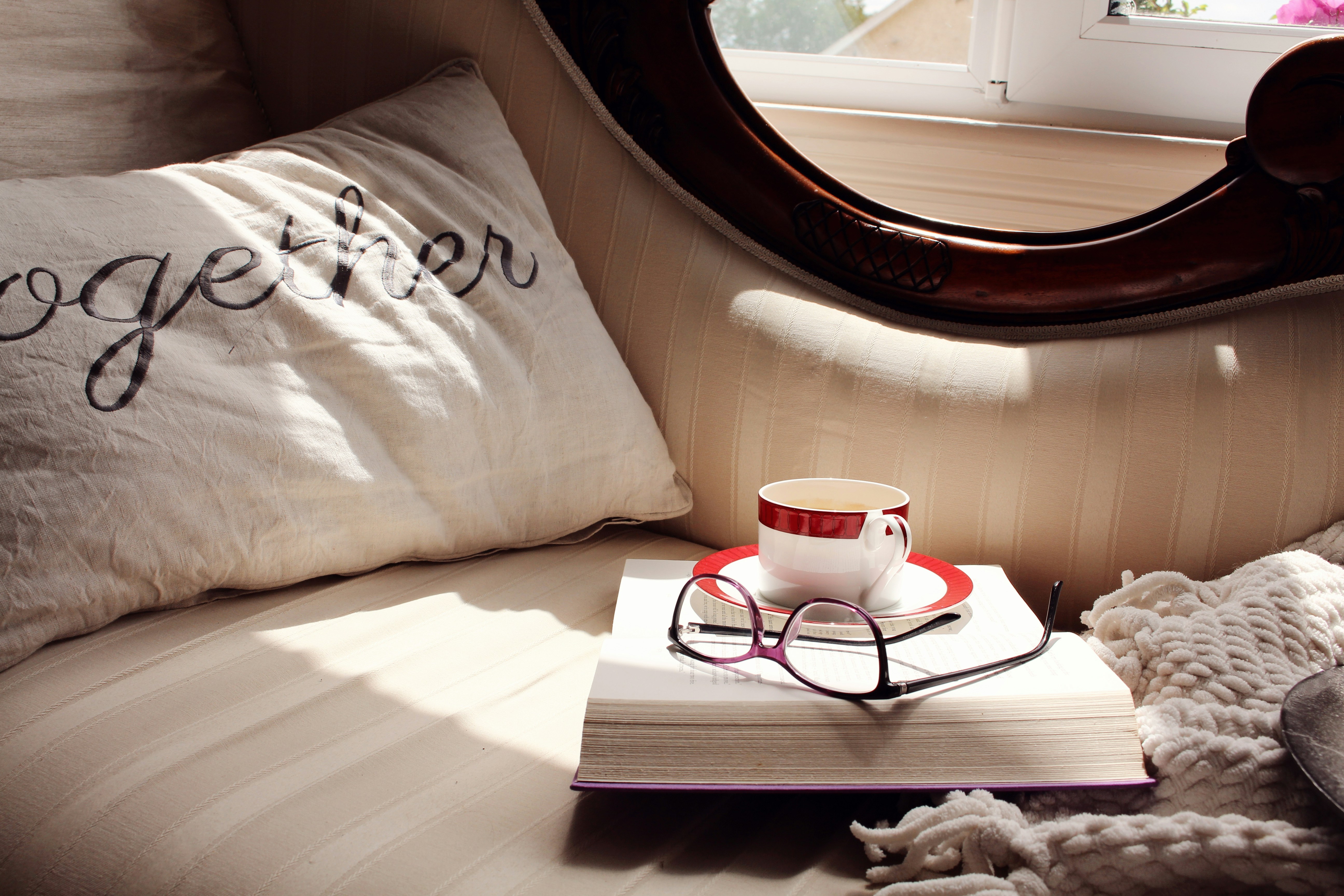 Cozy Reading Nook with Tea and Glasses on an Open Book