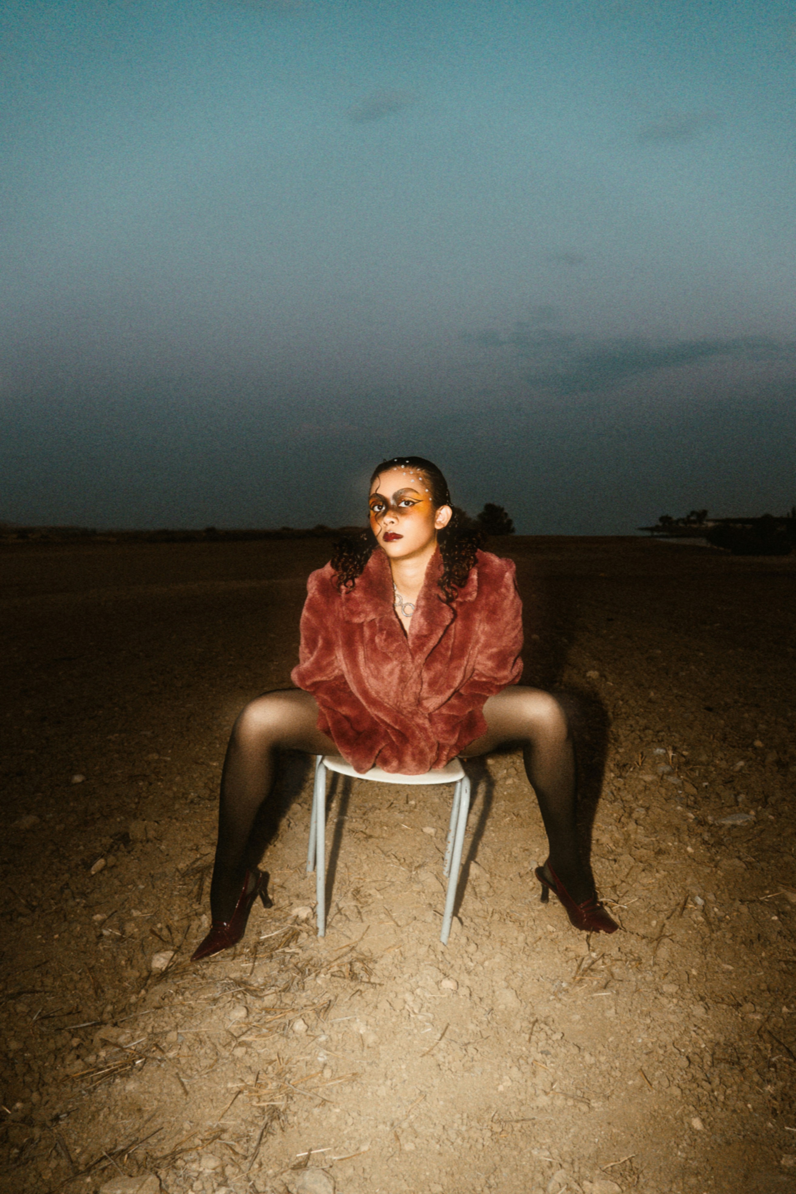 Midnight Studio: A Red Fur Coat Ignites the Desert Dusk