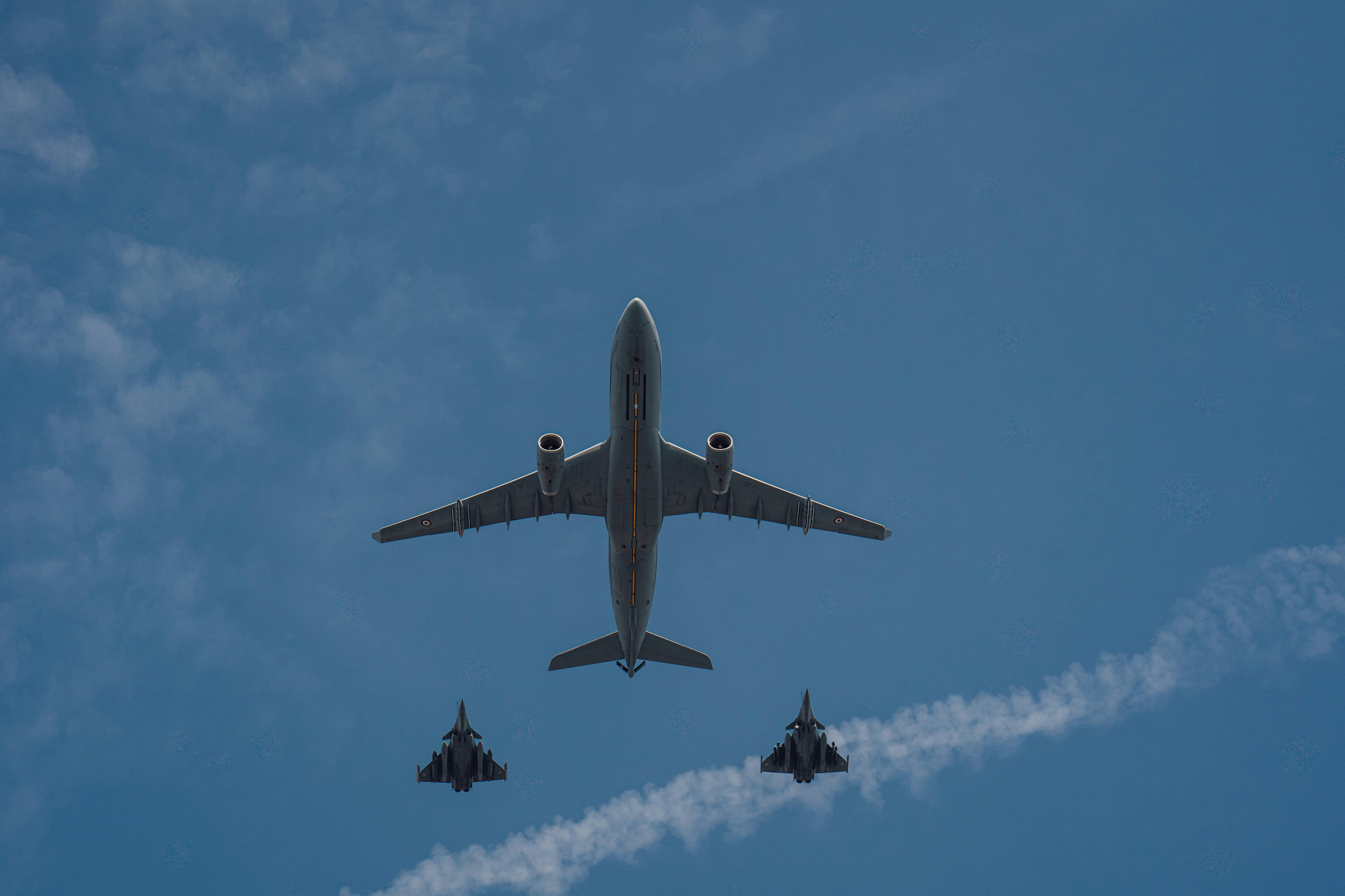 Underwing Duo: Jets Trace a White Vapor Path Across a Clear Blue Sky