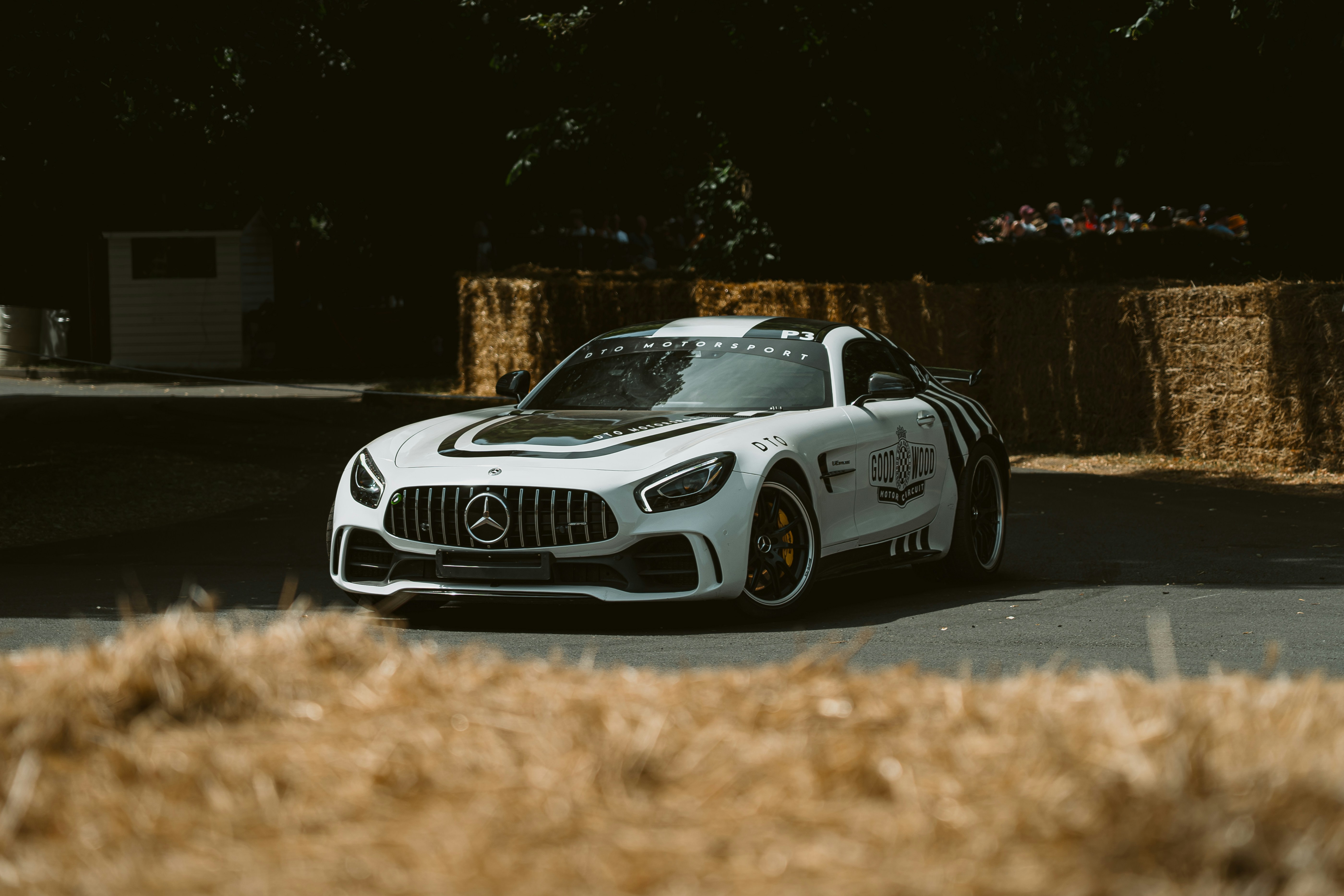 Mercury in Motion: White Mercedes GT3 Races Past a Sea of Hay Bills