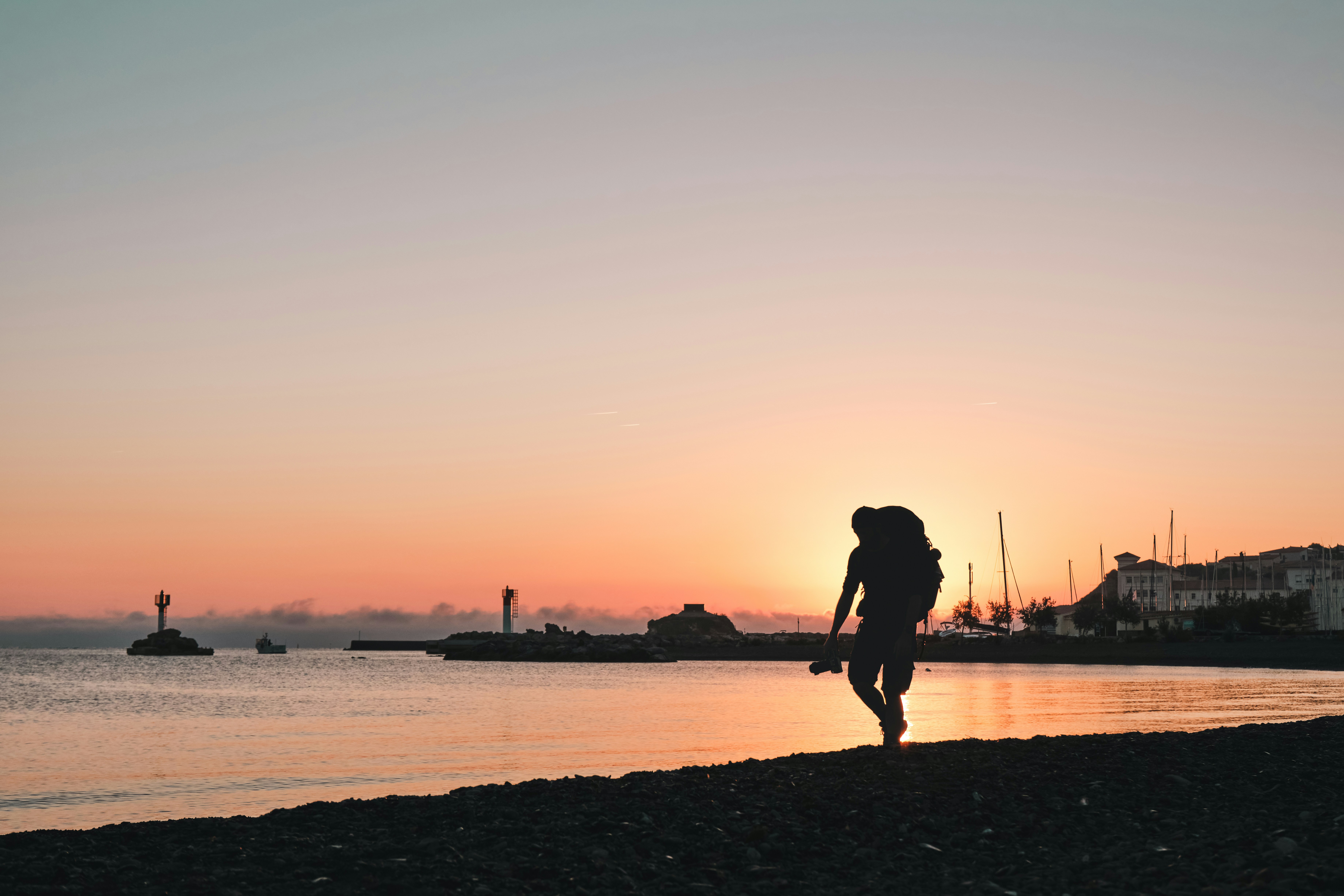 Silhouette at Dusk: A Wanderer by the Quiet Shore