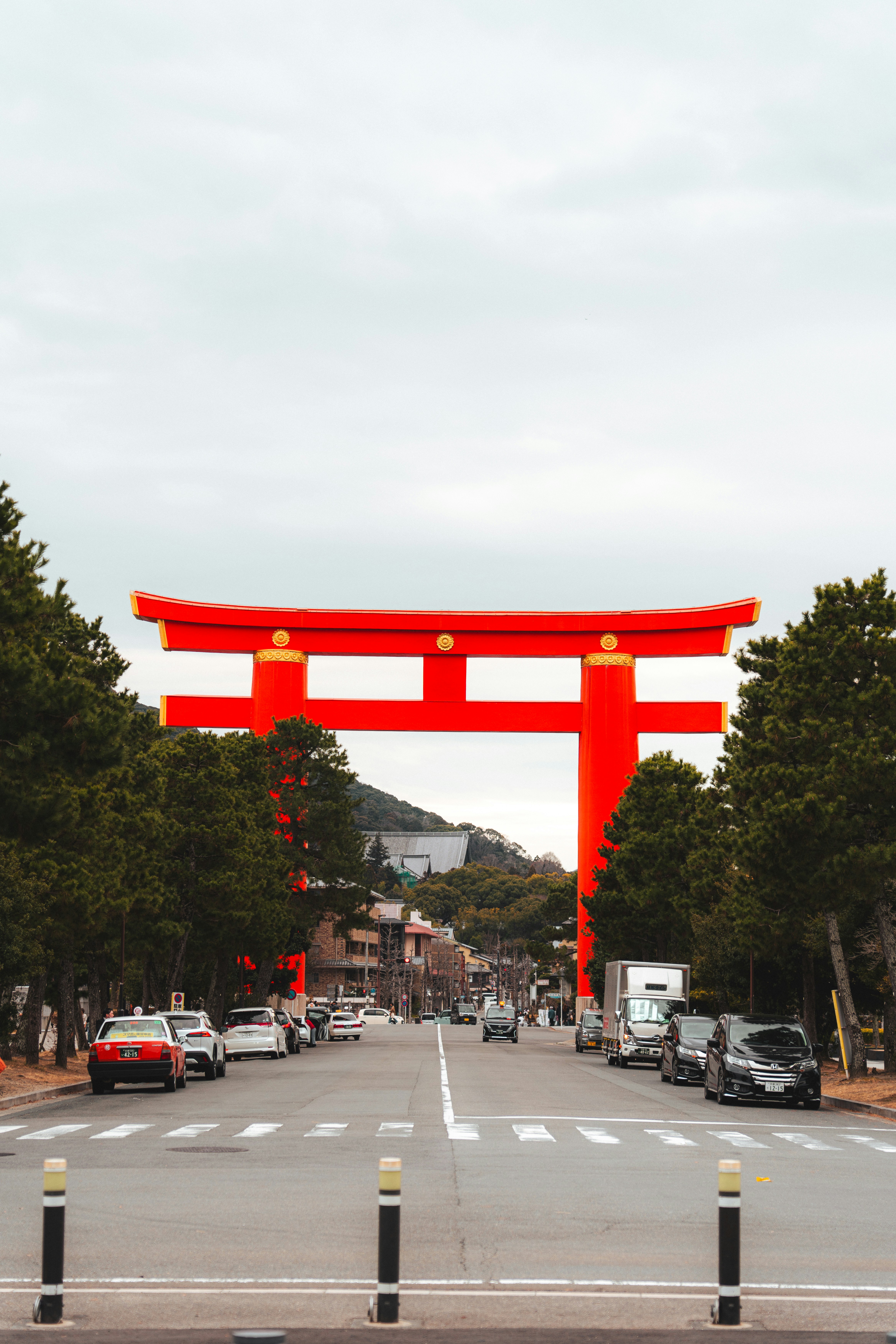 Red Gate to the Street: A Torii Arc Framing a Quiet Avenue