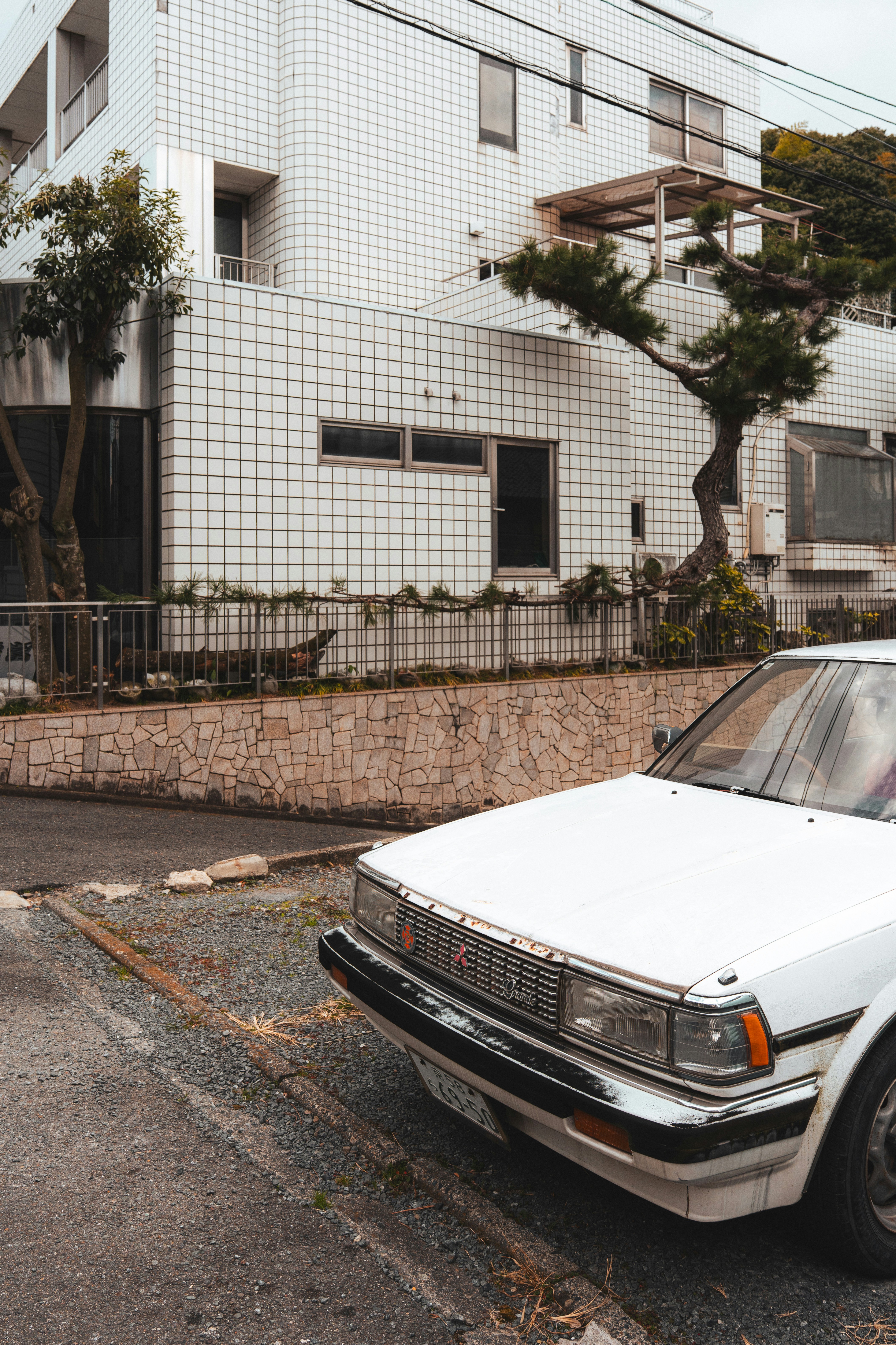 White Facade and Vintage Car: A Quiet Street Moment