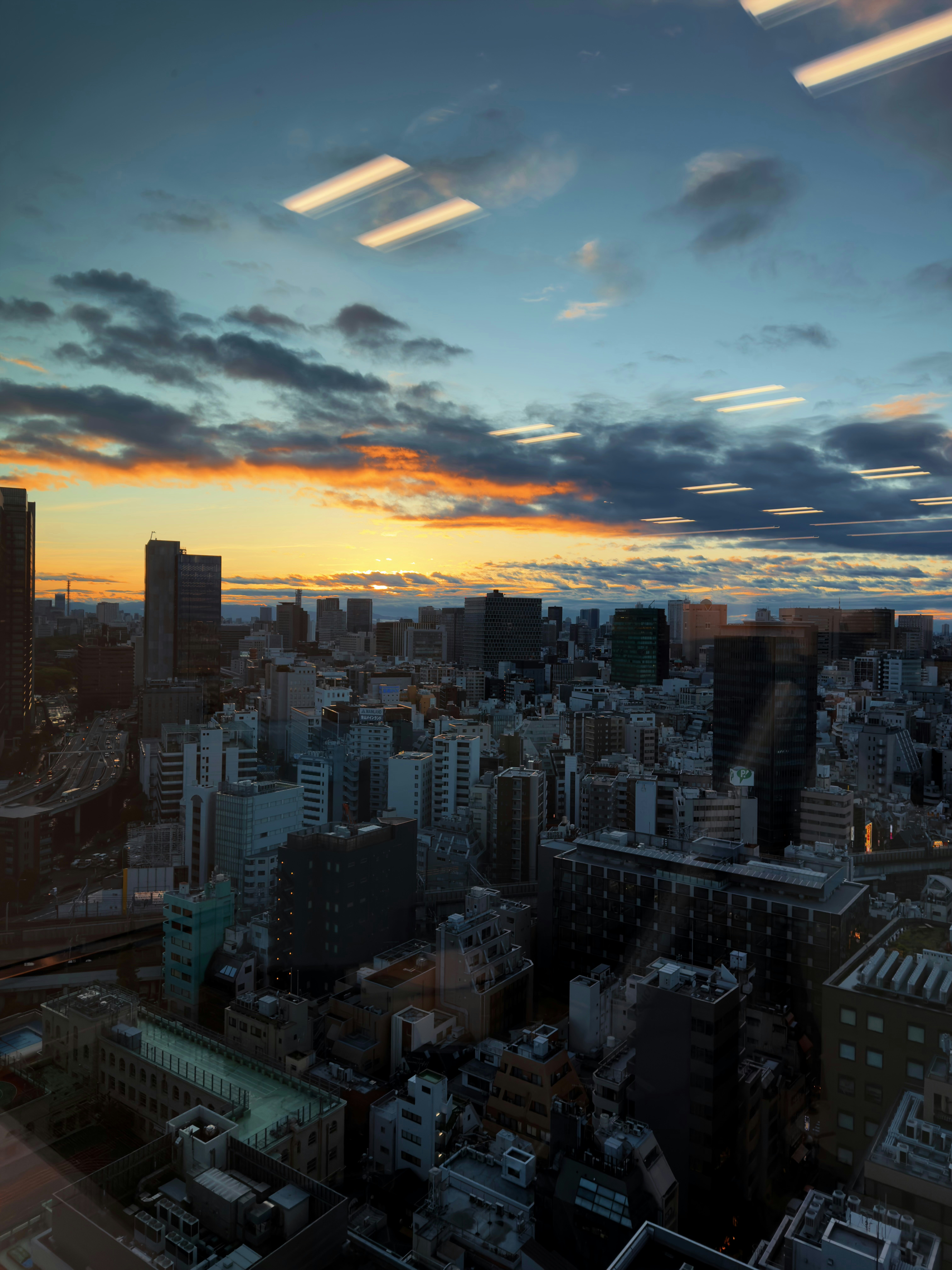 Sunset Over a Dense Cityscape Through a Window