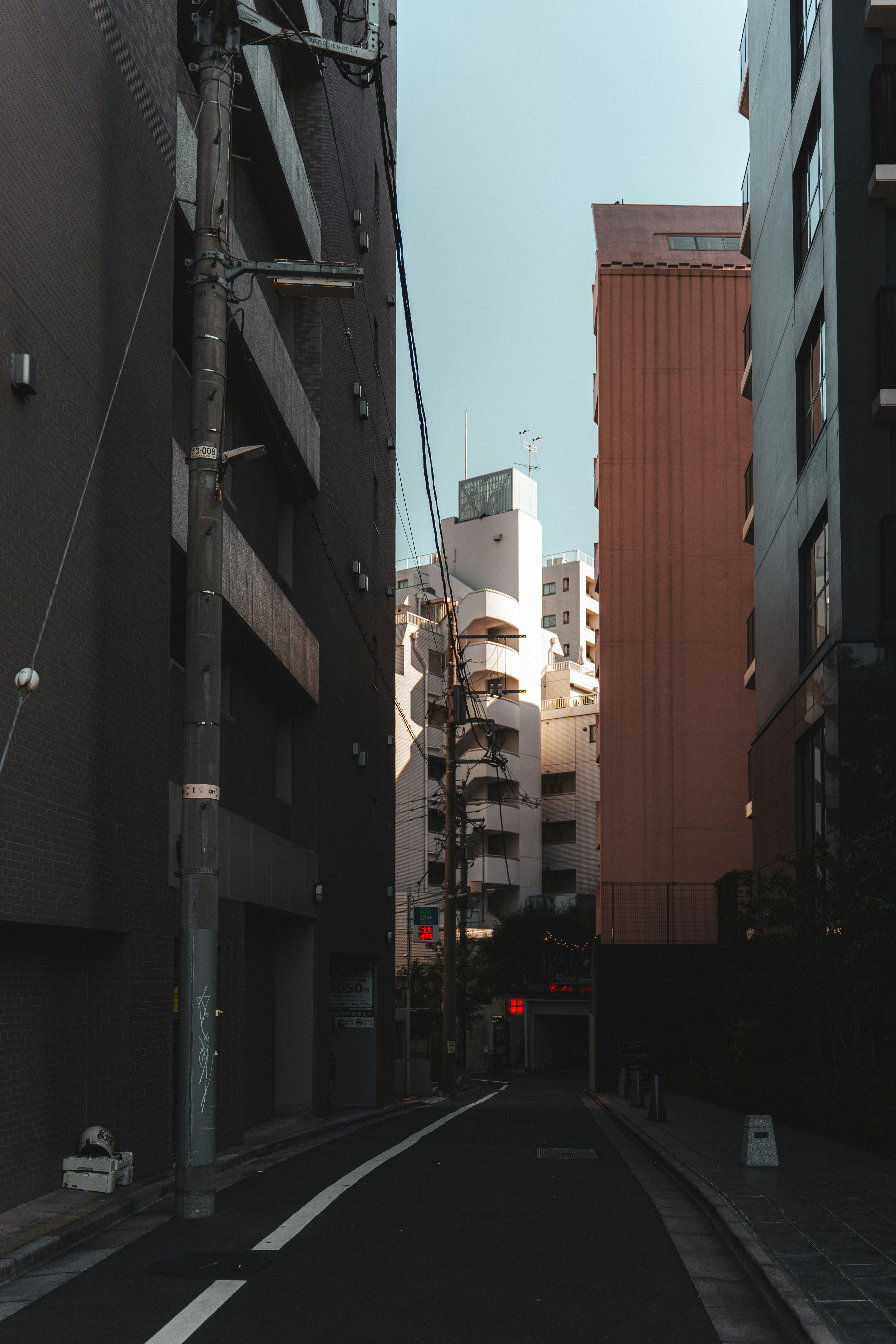 Urban Canyon: Sunlit Gap Between Concrete Skyscrapers