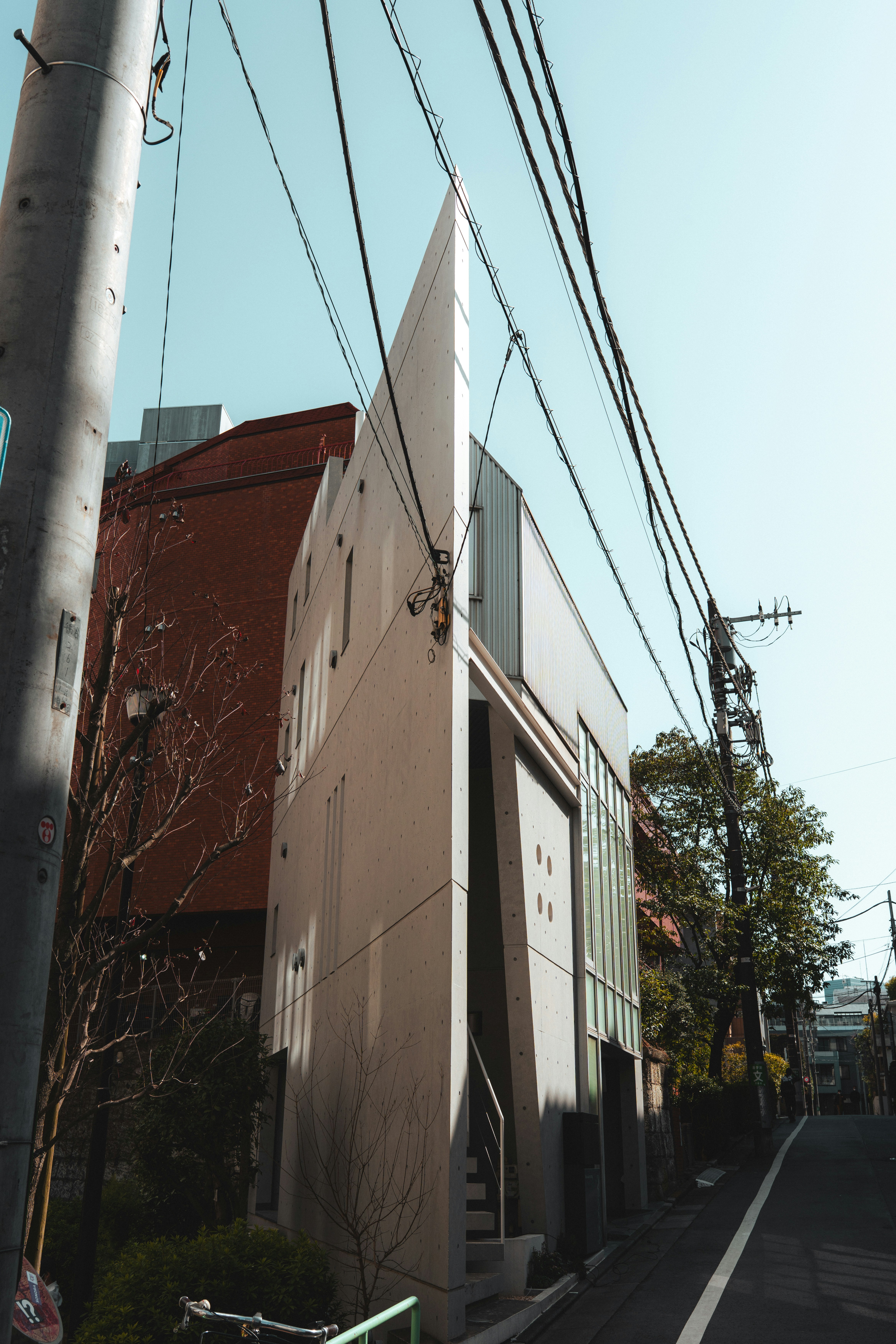 Urban Geometry: Concrete Facade Framed by Cables and Light