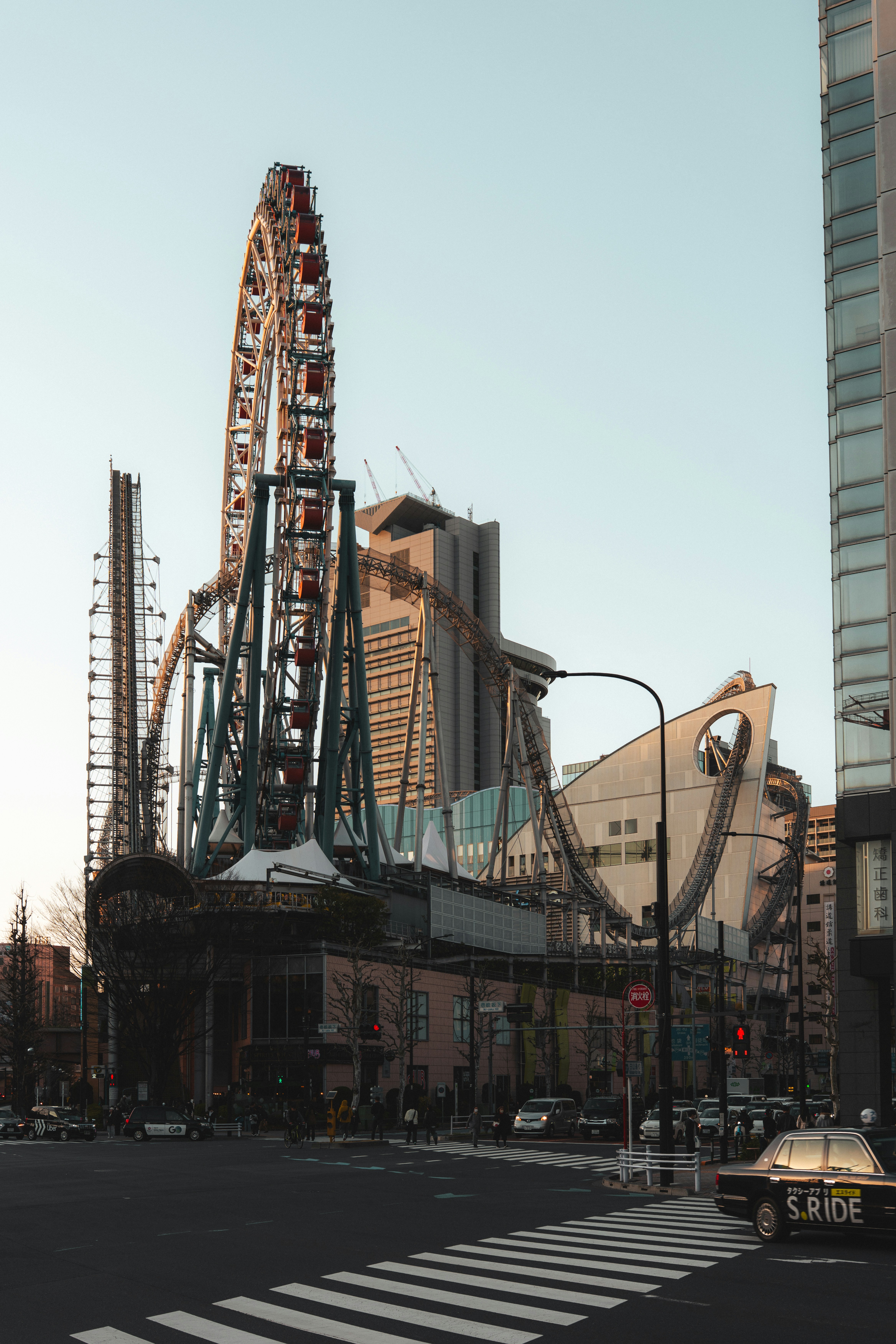 Urban Ferris Wheel Framed by Modern Architecture at Sunset