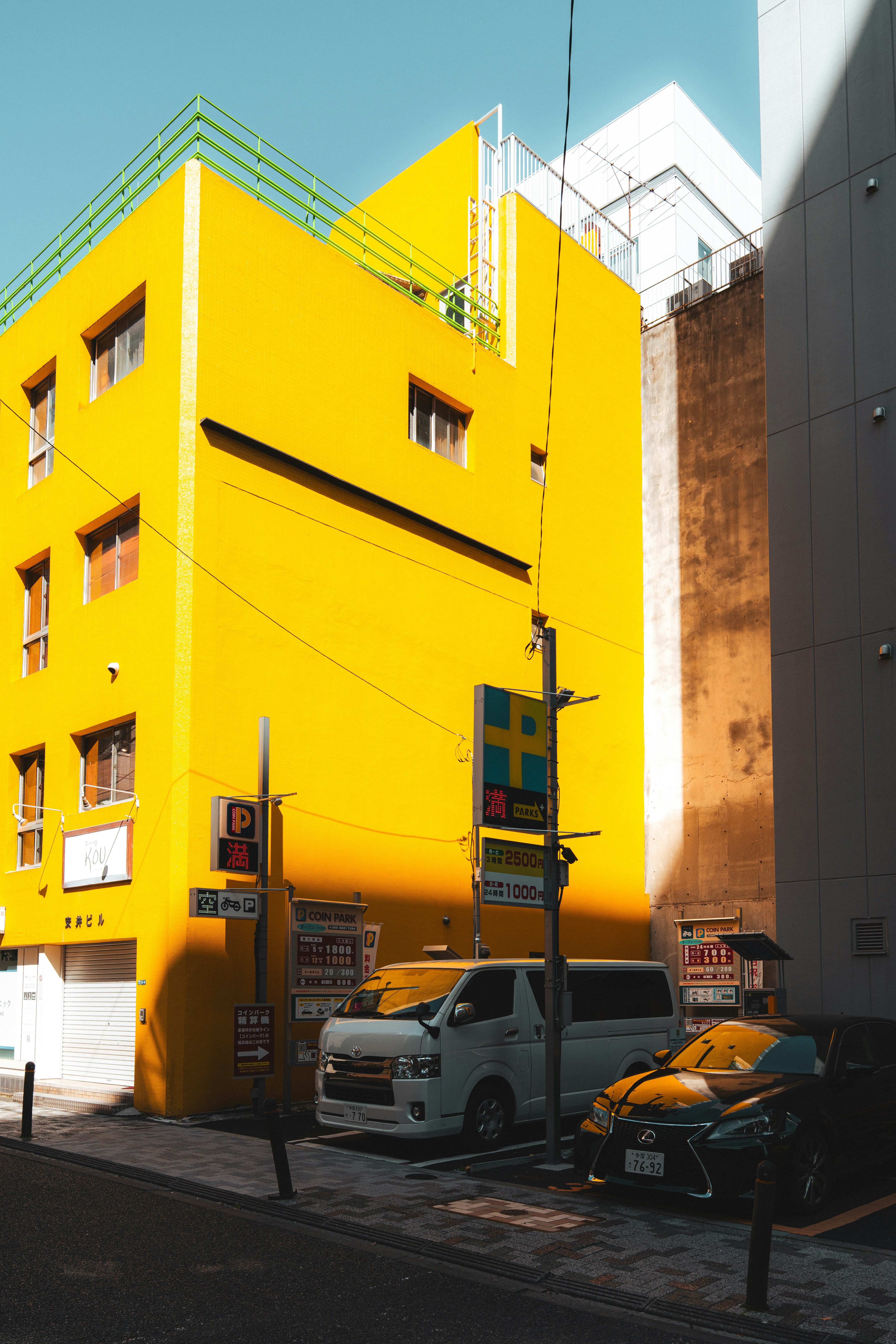 Chromatic Corner: A Bold Yellow Facade Beckons Over The Quiet Street