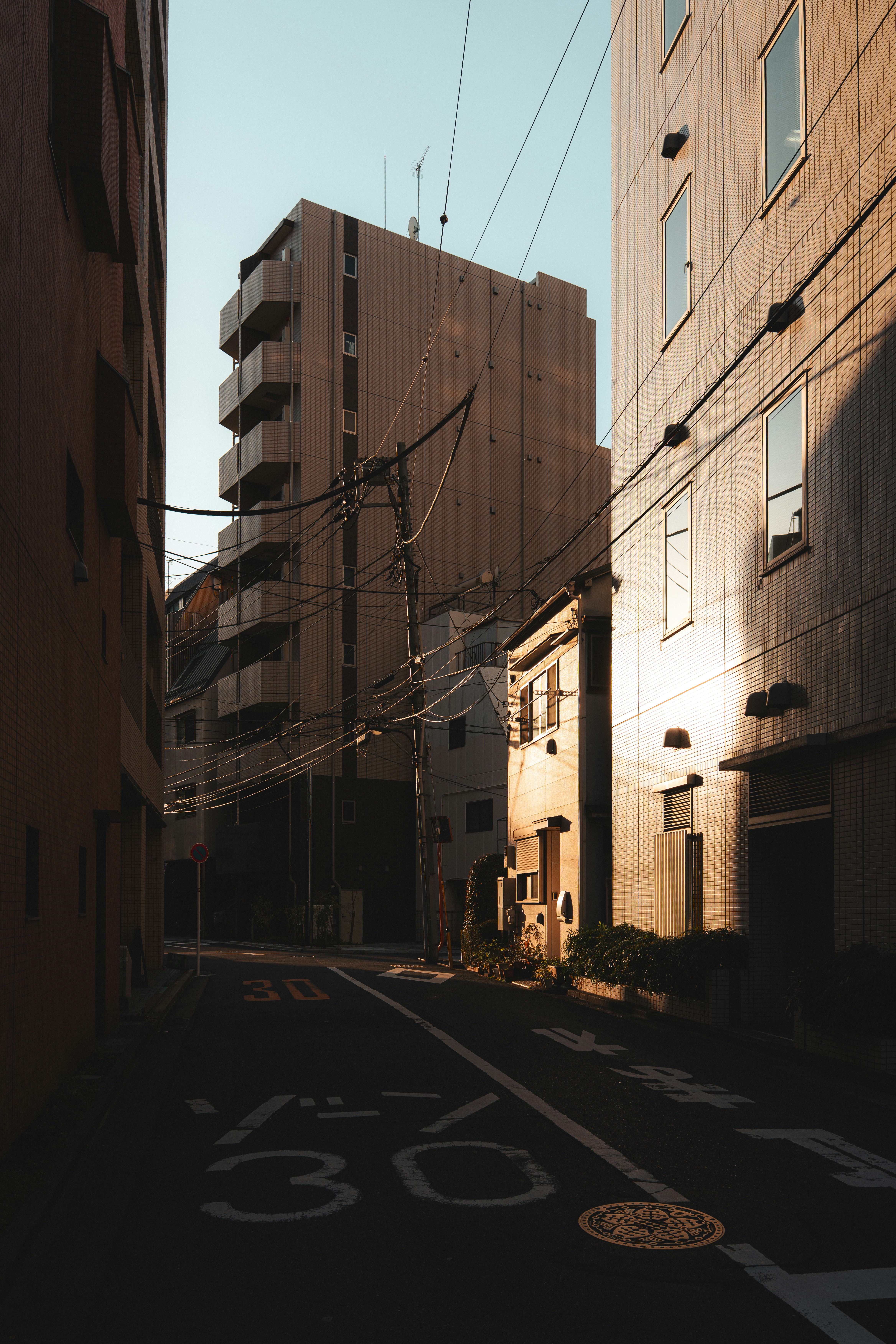 Sunlit Alleyway: A Quiet Corridor Between Towers