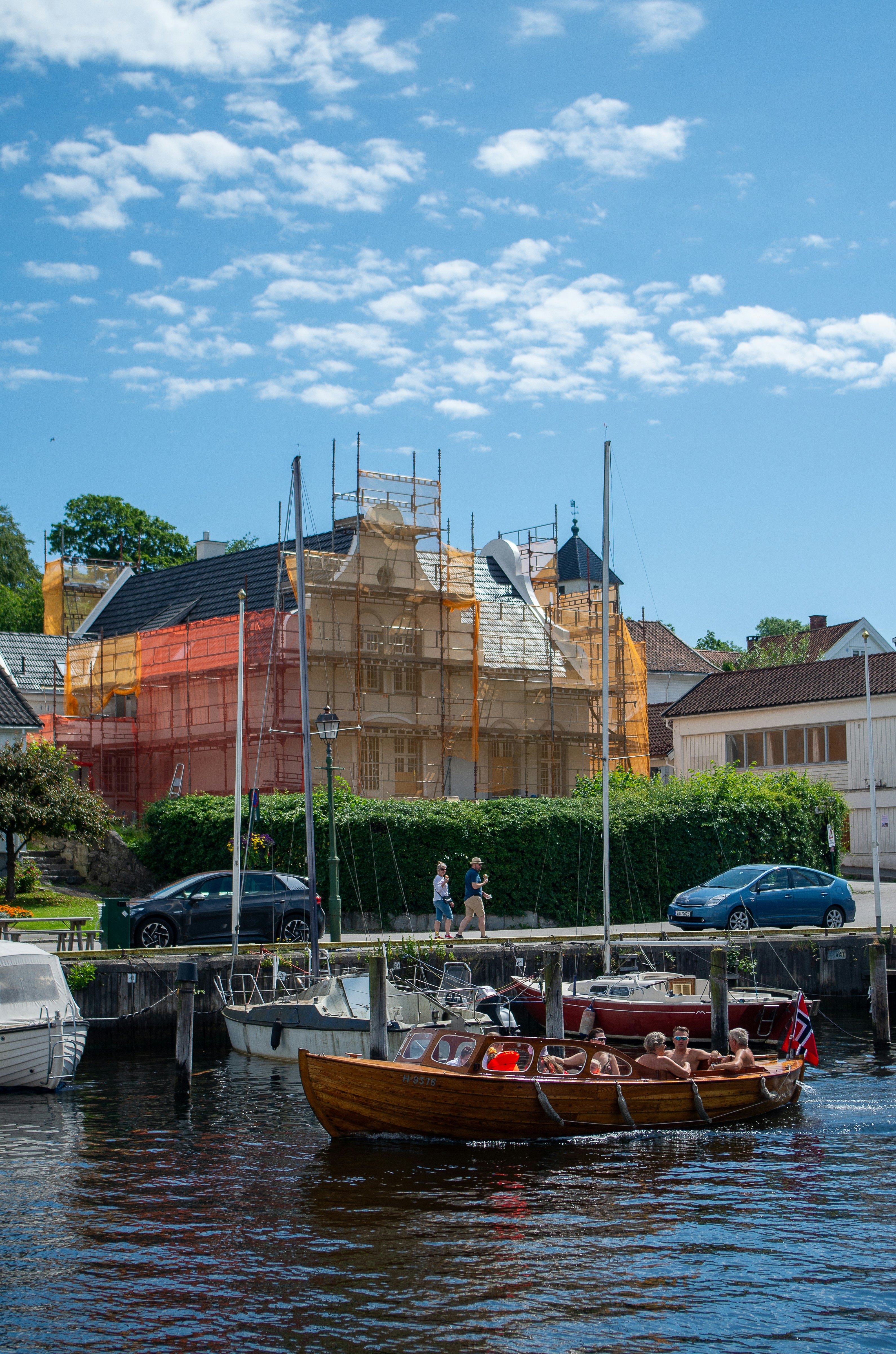 Harbor Construction: Sunlit House Under Renovation Framed by Boatmen