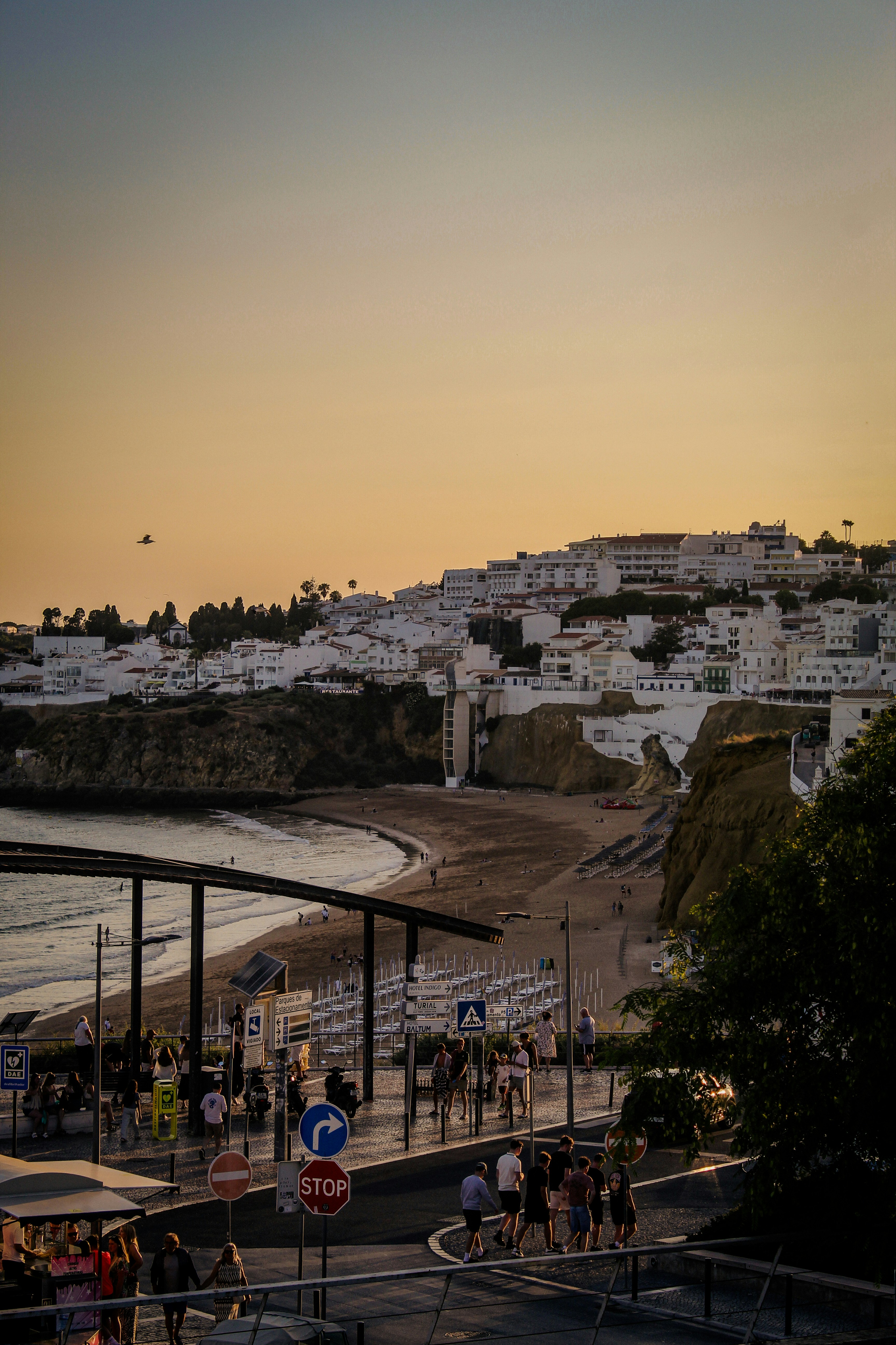 Sunset Above a Cliffside Town: Beachfront Path and Quiet Horizon