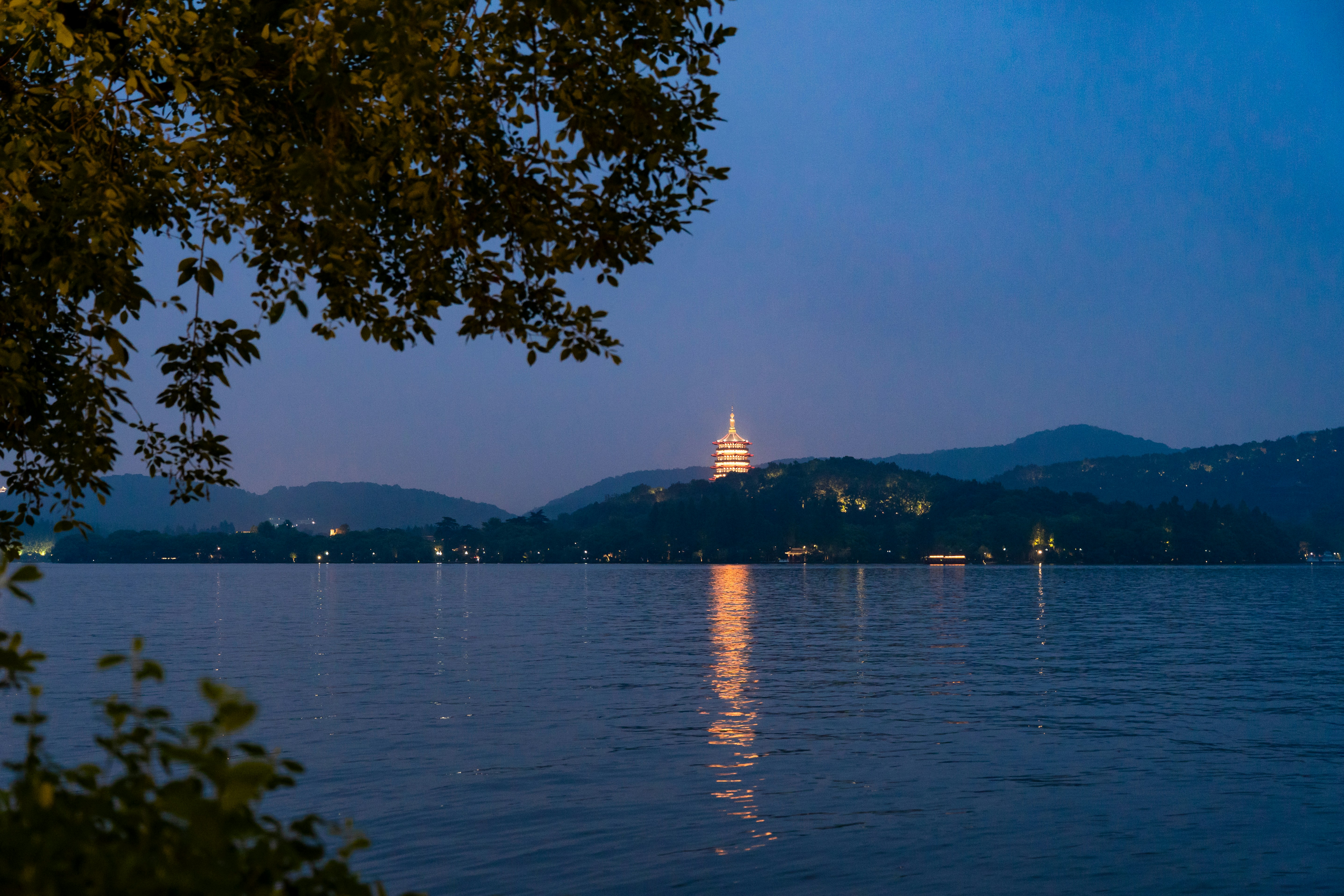 Lone Pagoda Silhouette Across the Evening Lake