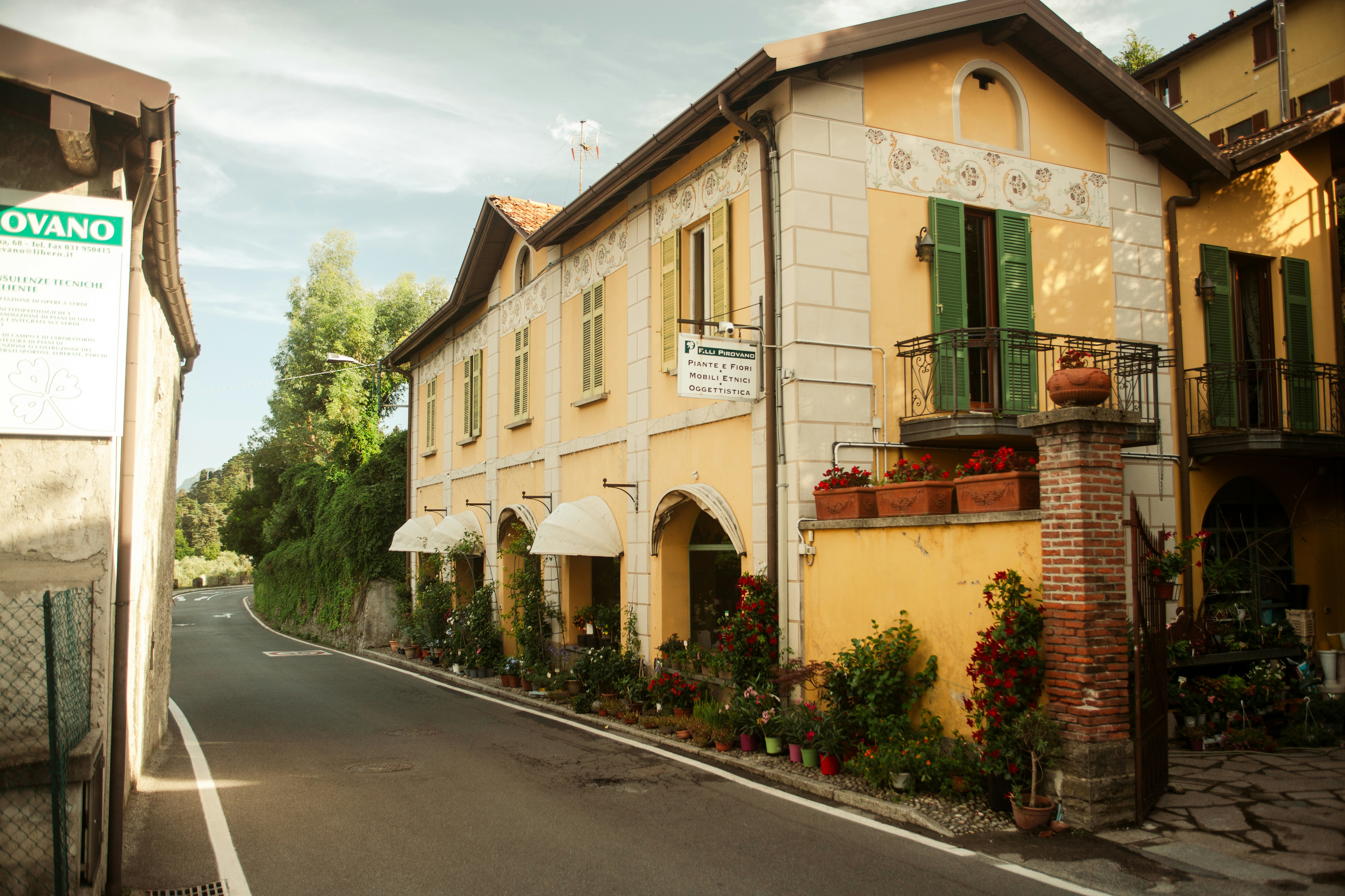 Sunny Mediterranean Street: Colorful Villa Corner with Flourishing Balcony Garden