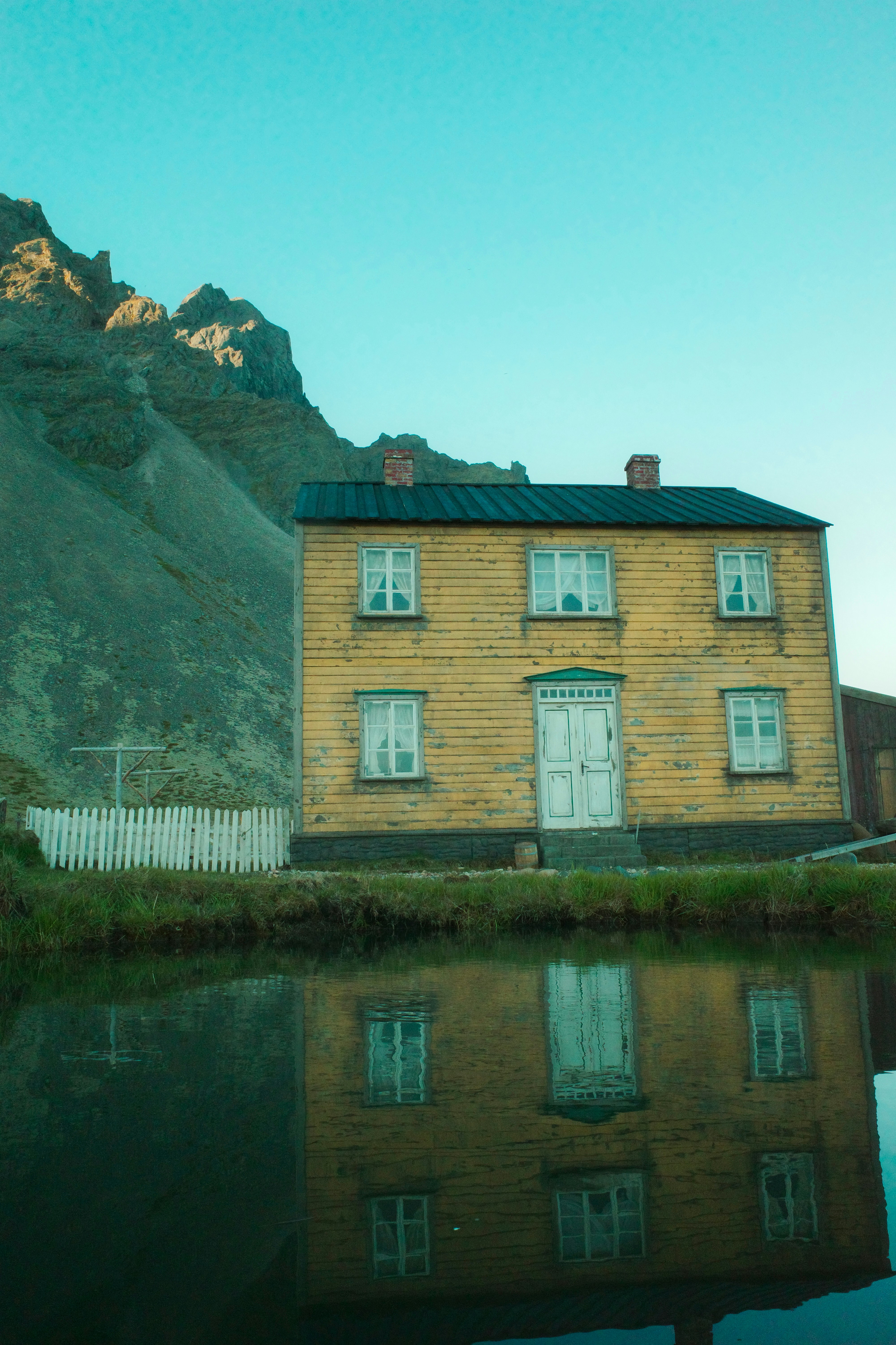Lone Yellow House by Still Waters at Dusk