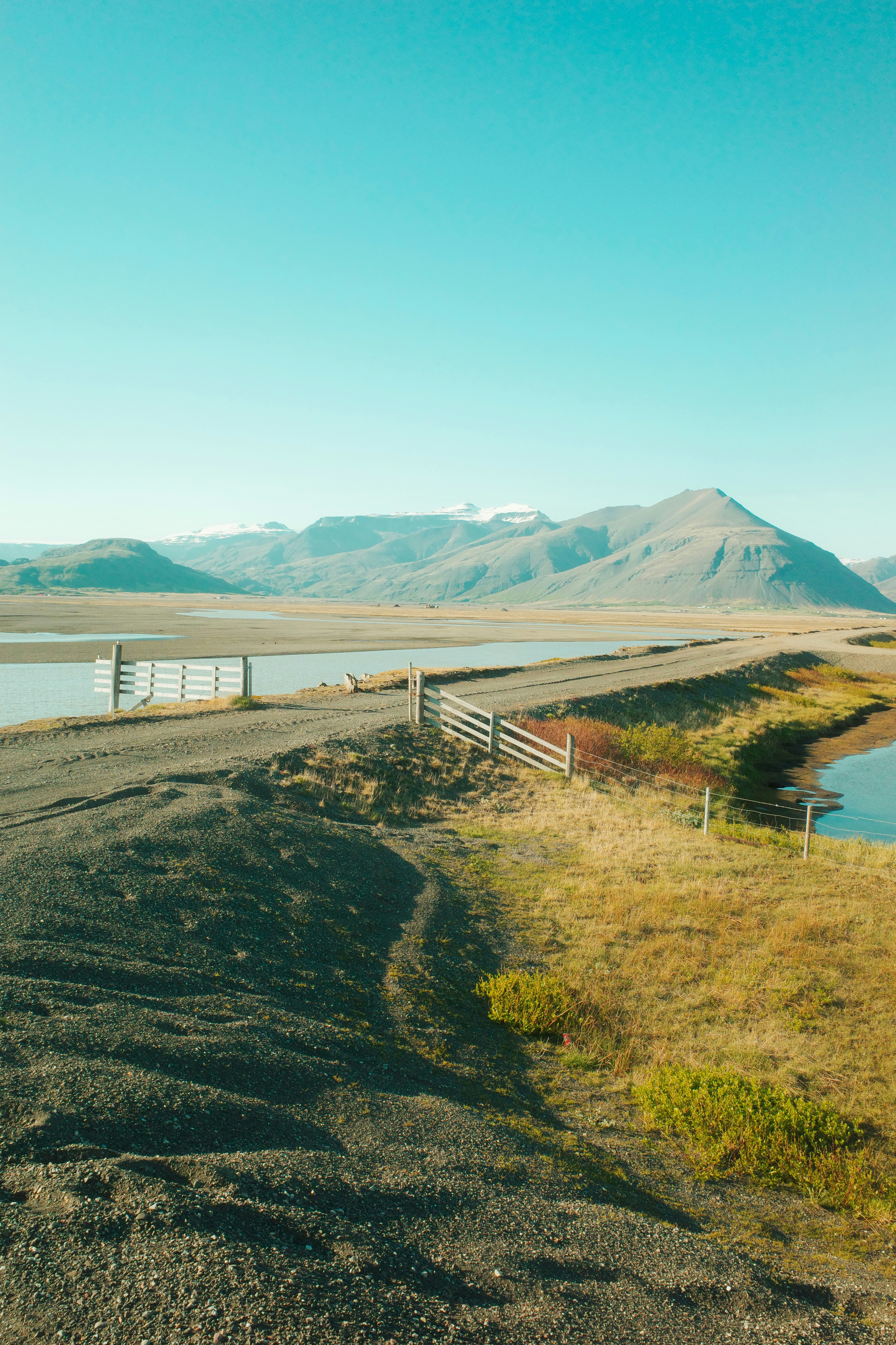 Where River Meets Dunes: A Quiet Arc Toward Snow-Capped Peaks