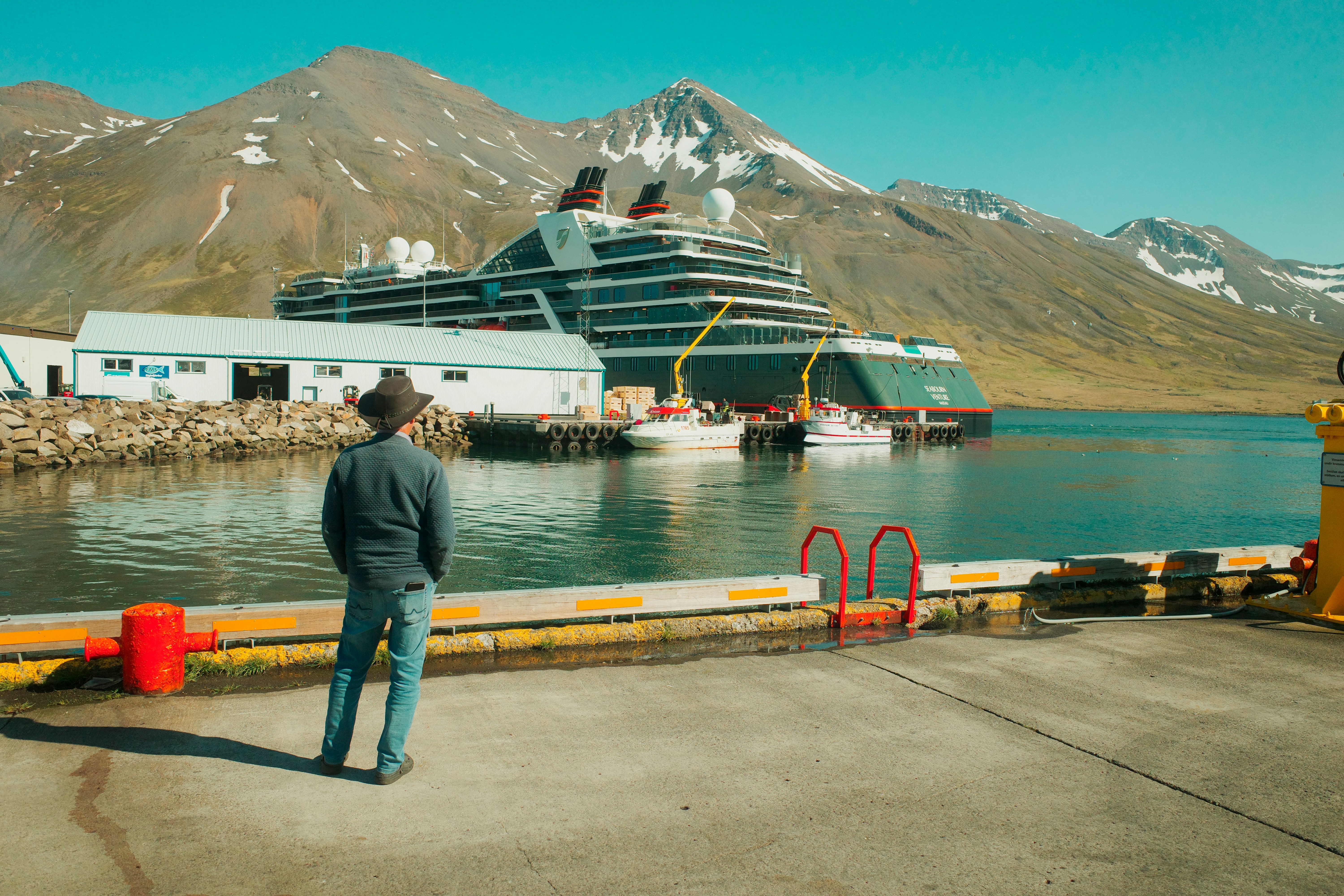 Harbor View: A Lone Observer Gazes at a Megalithic Cruise