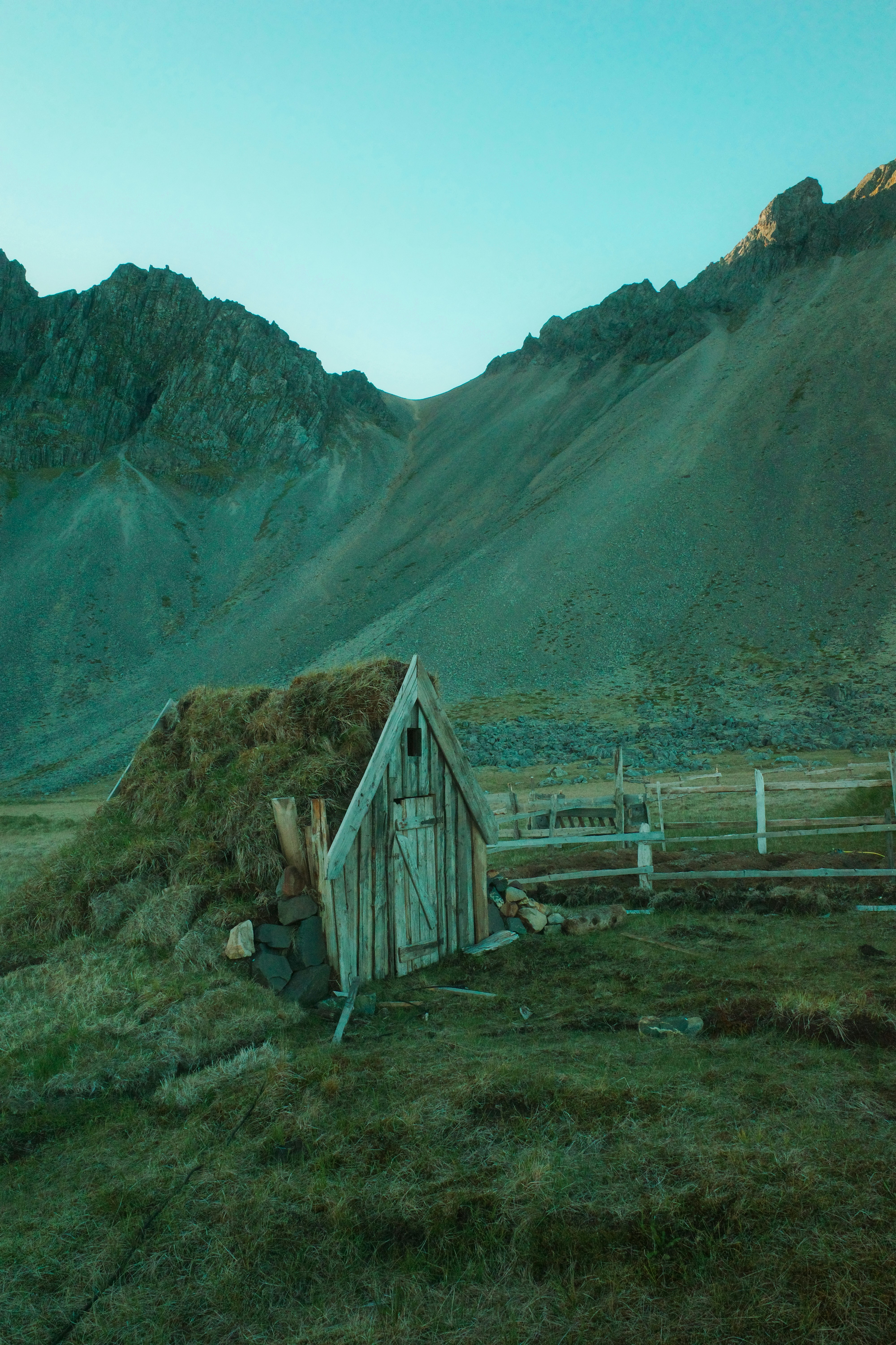 Weathered A-frame Door amid Mountain Pasture