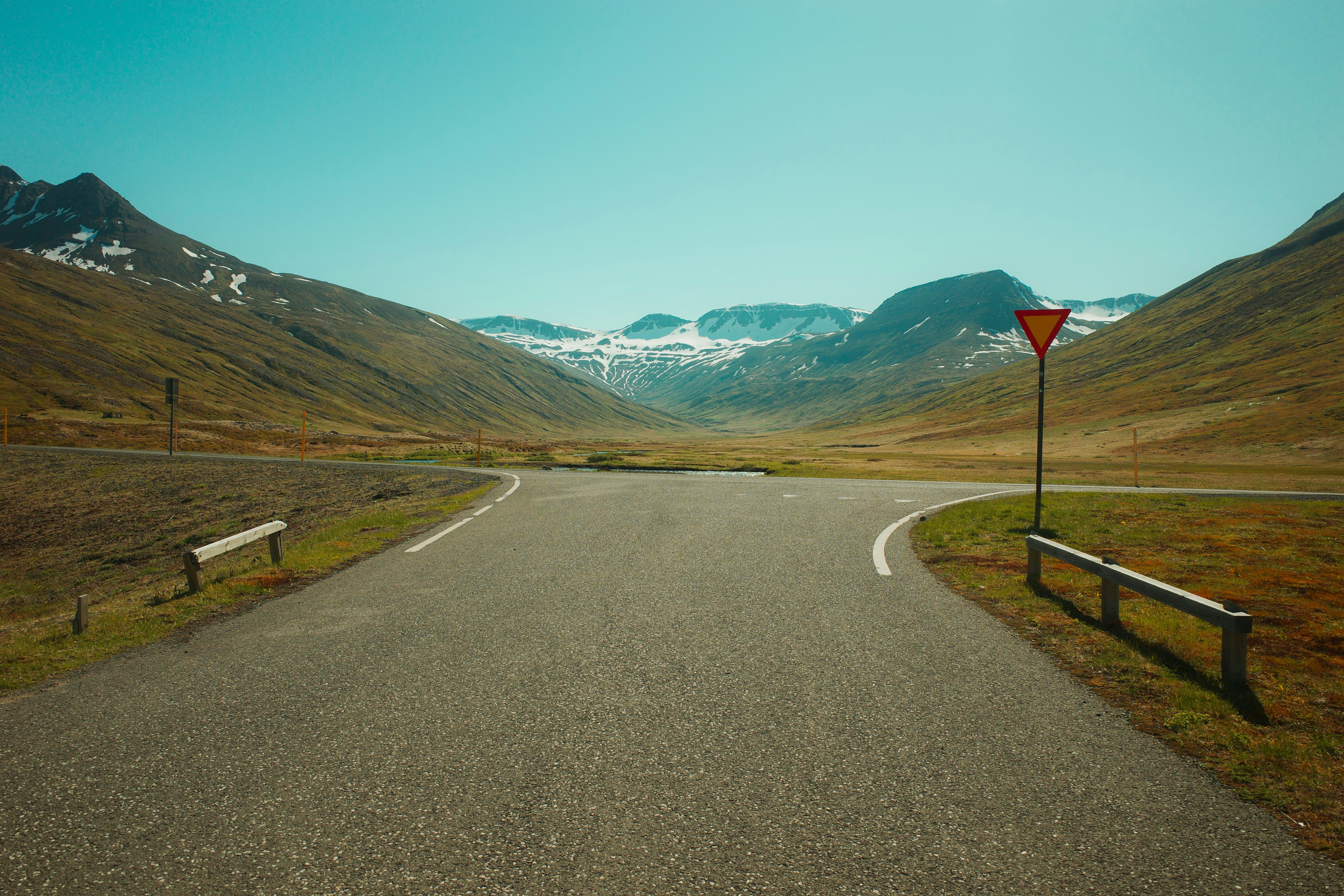 Open-Road Arc toward Snow-Capped Peaks