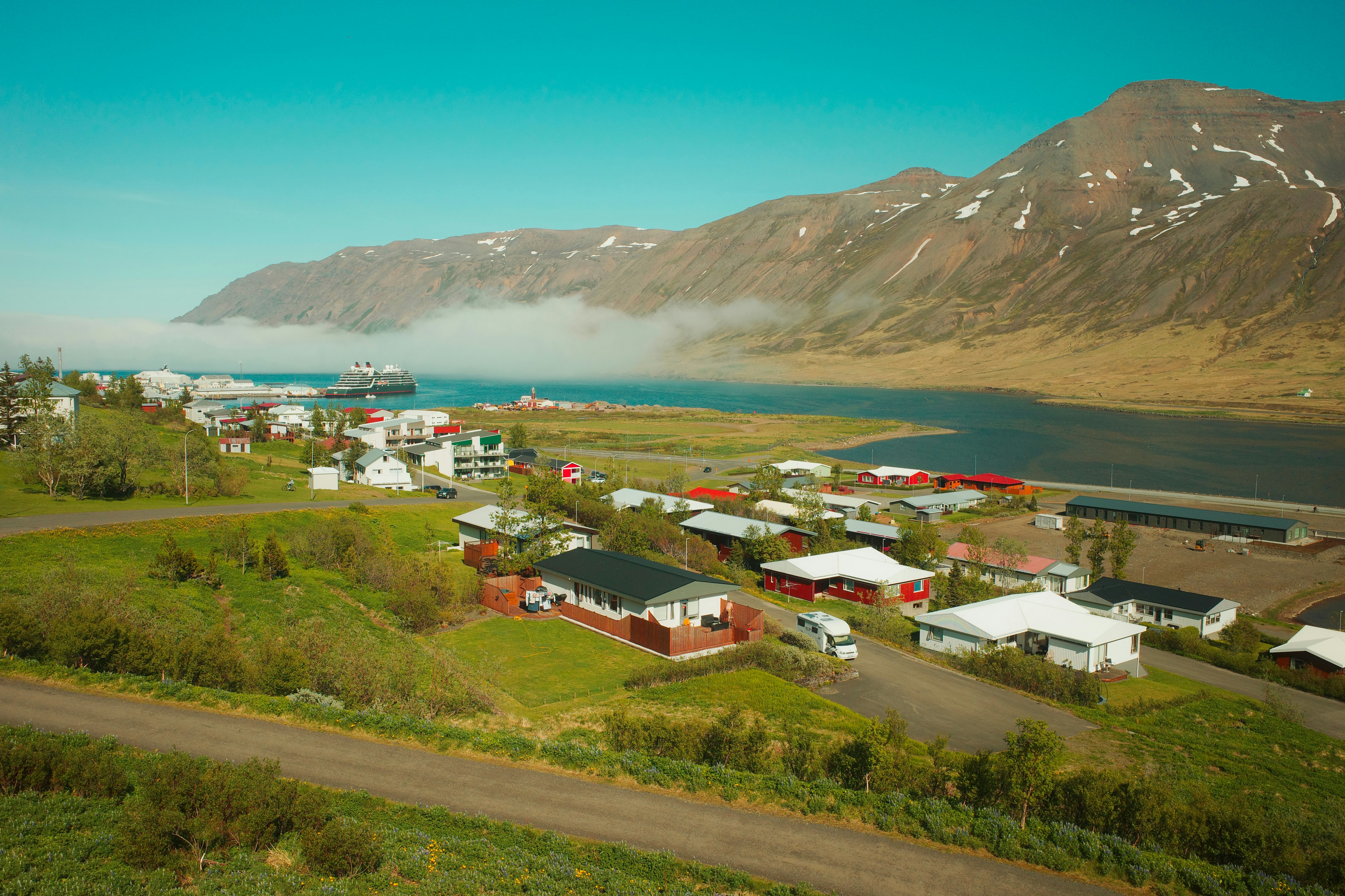Colors of a Coastal Village Under a Misty Fjord