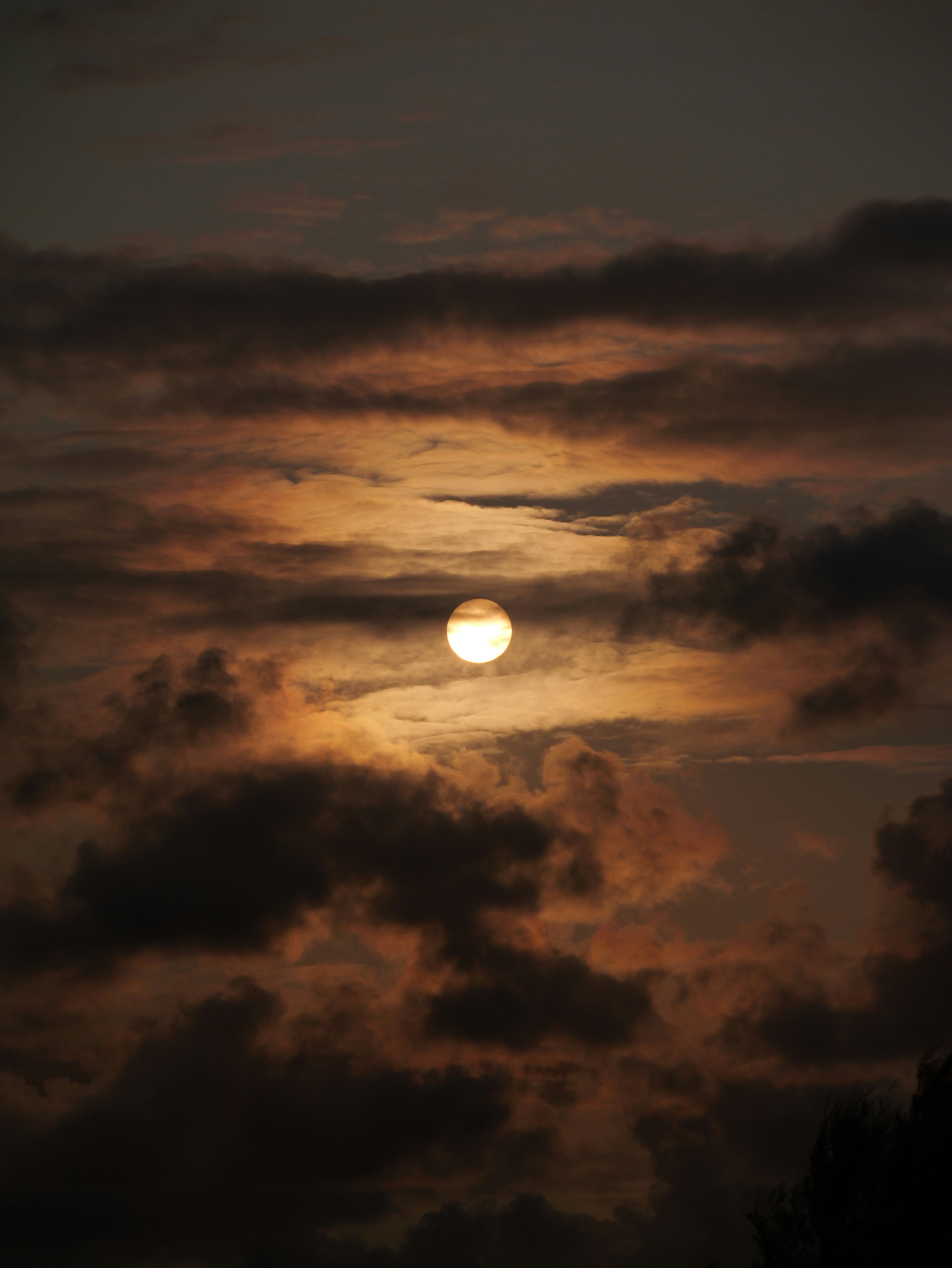 Low-sun Halo: The Moonlit Sky Through Clouds at Dusk