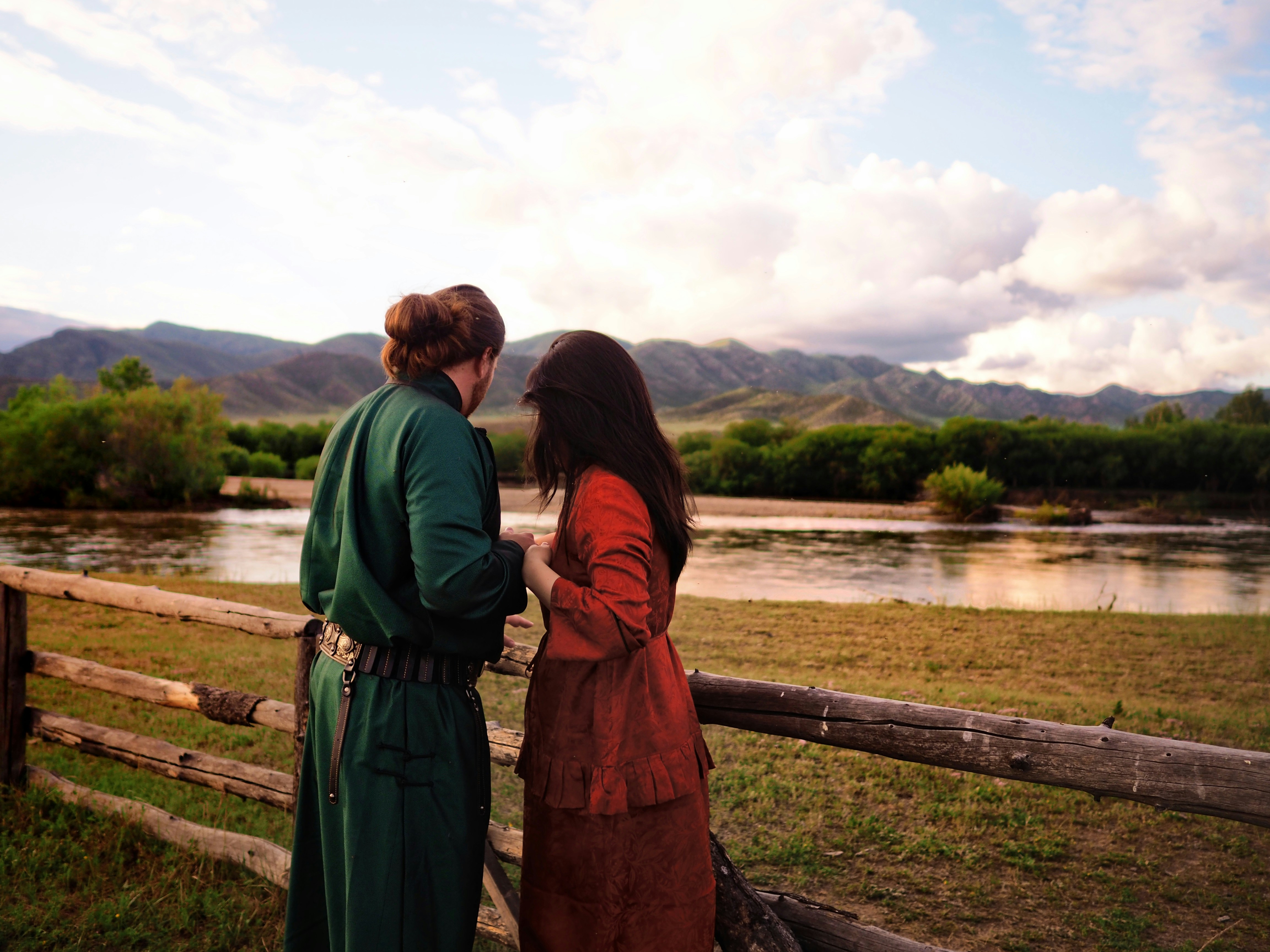 Whispered Exchange by the Riverside Fence