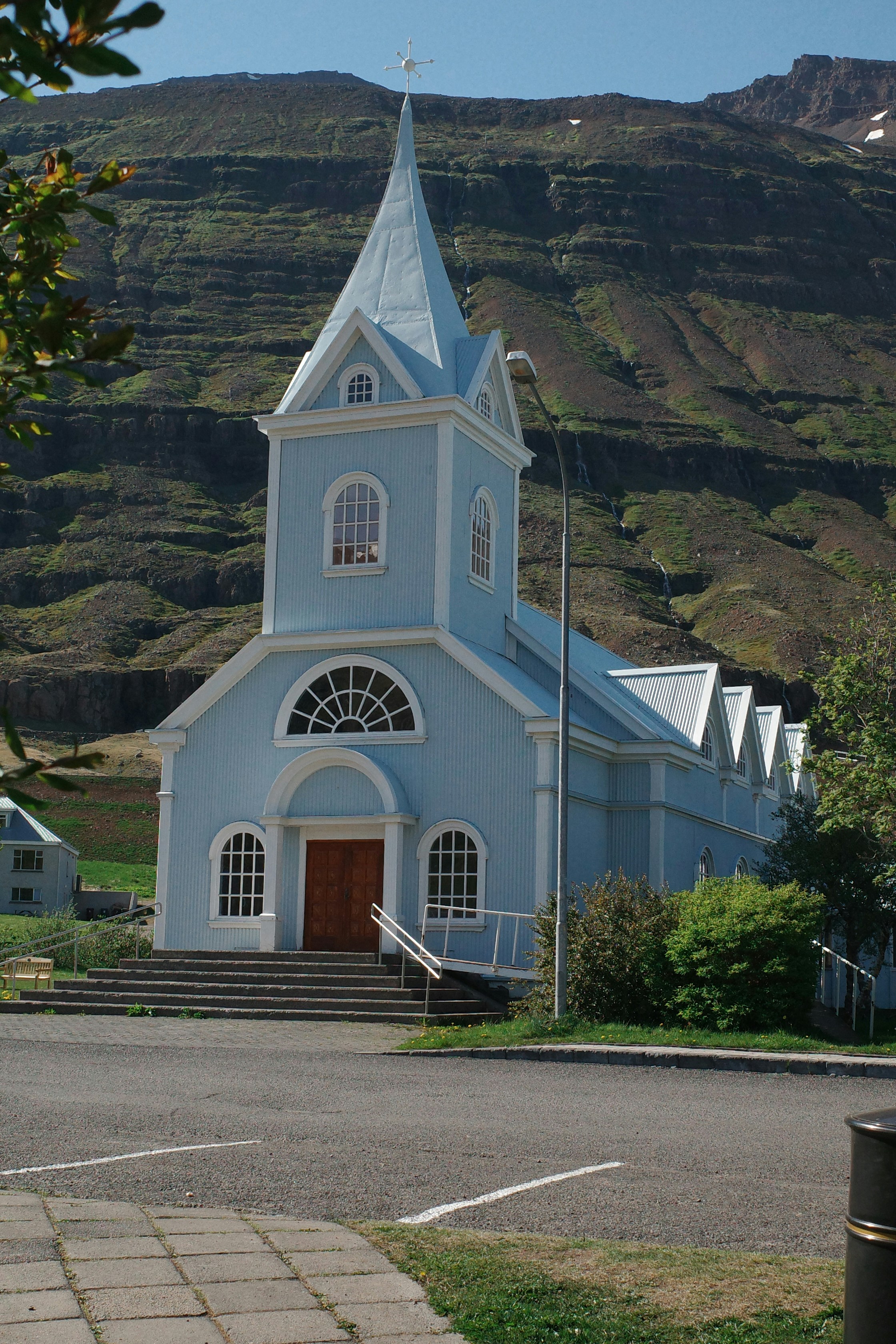 Blue Chapel on a Bright Coastal Slope