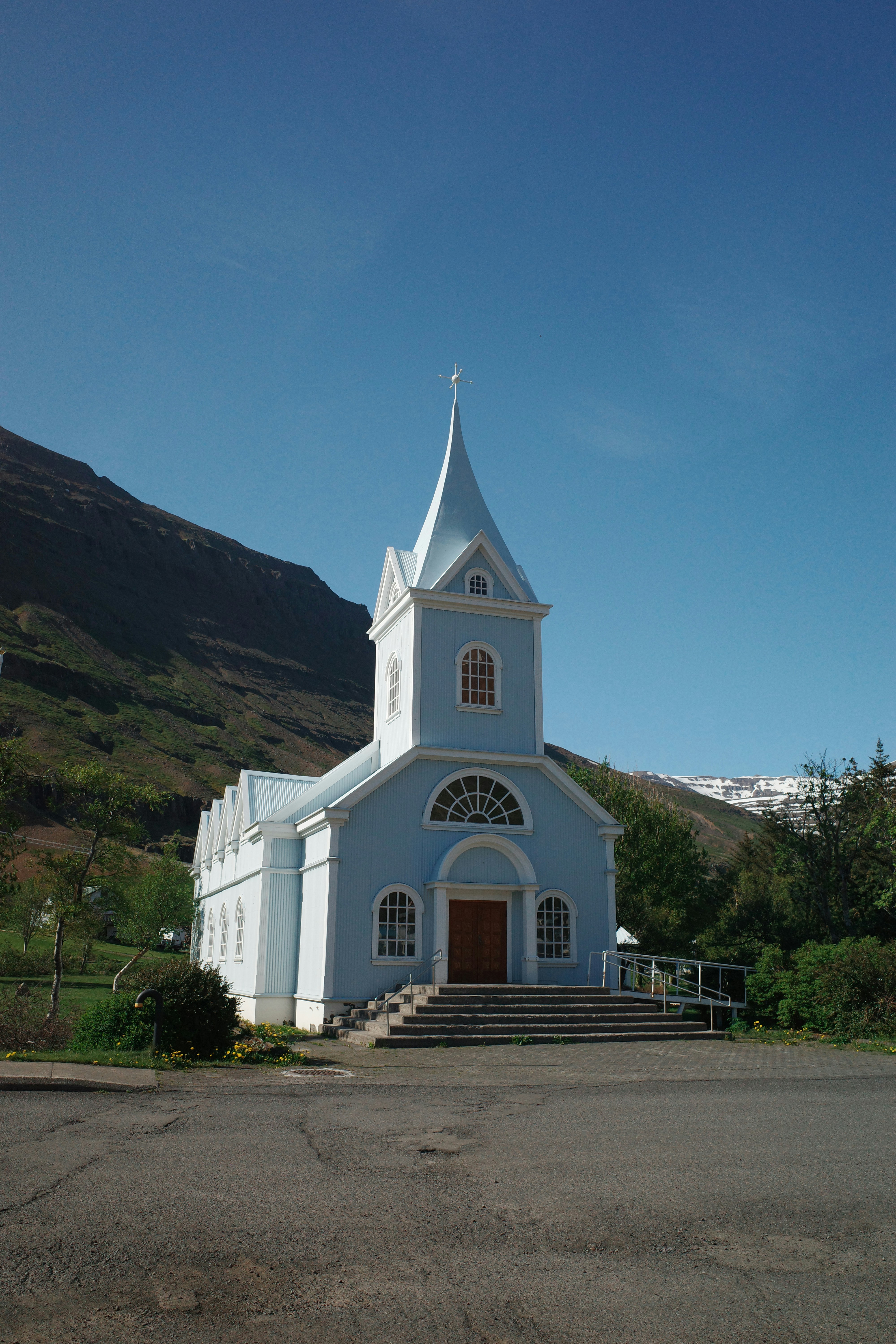 Blue Church Under a Clear Sky in a Quiet Valley