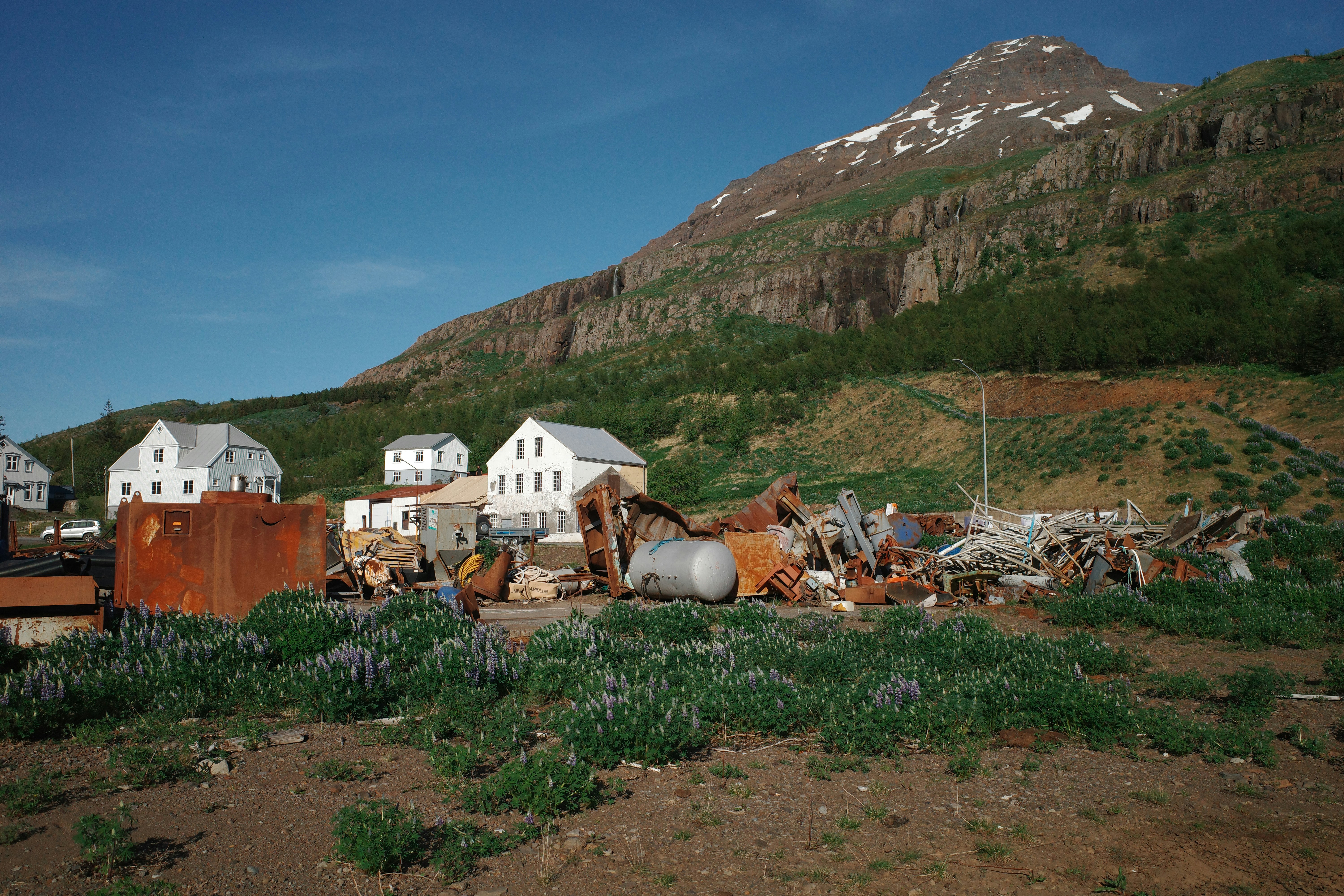 Mud-Tone Scrapyard at the Foot of a Snow-Capped Peak