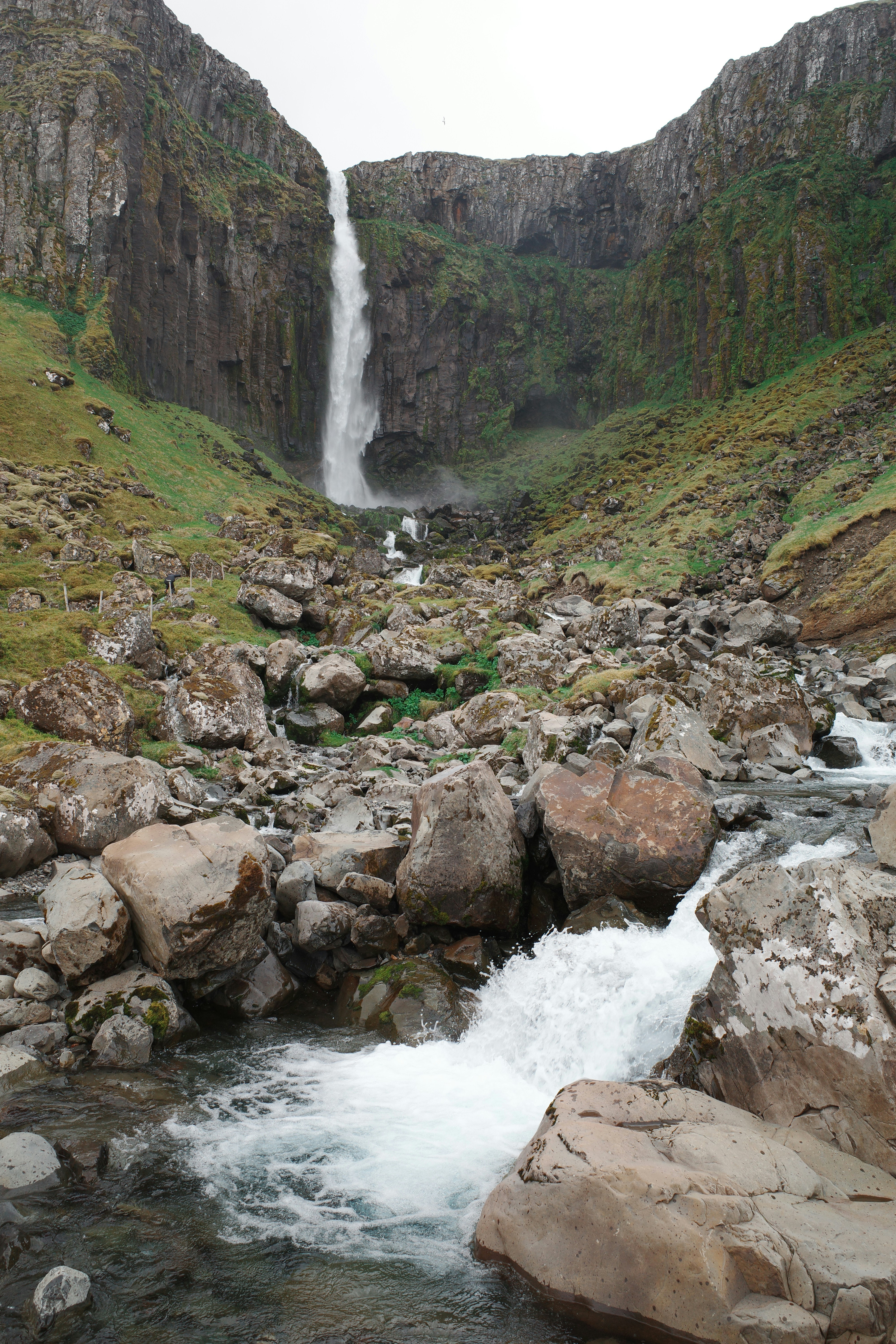 Cascade Between Weathered Cliffs: A Ribbon of White Through Rough Stones
