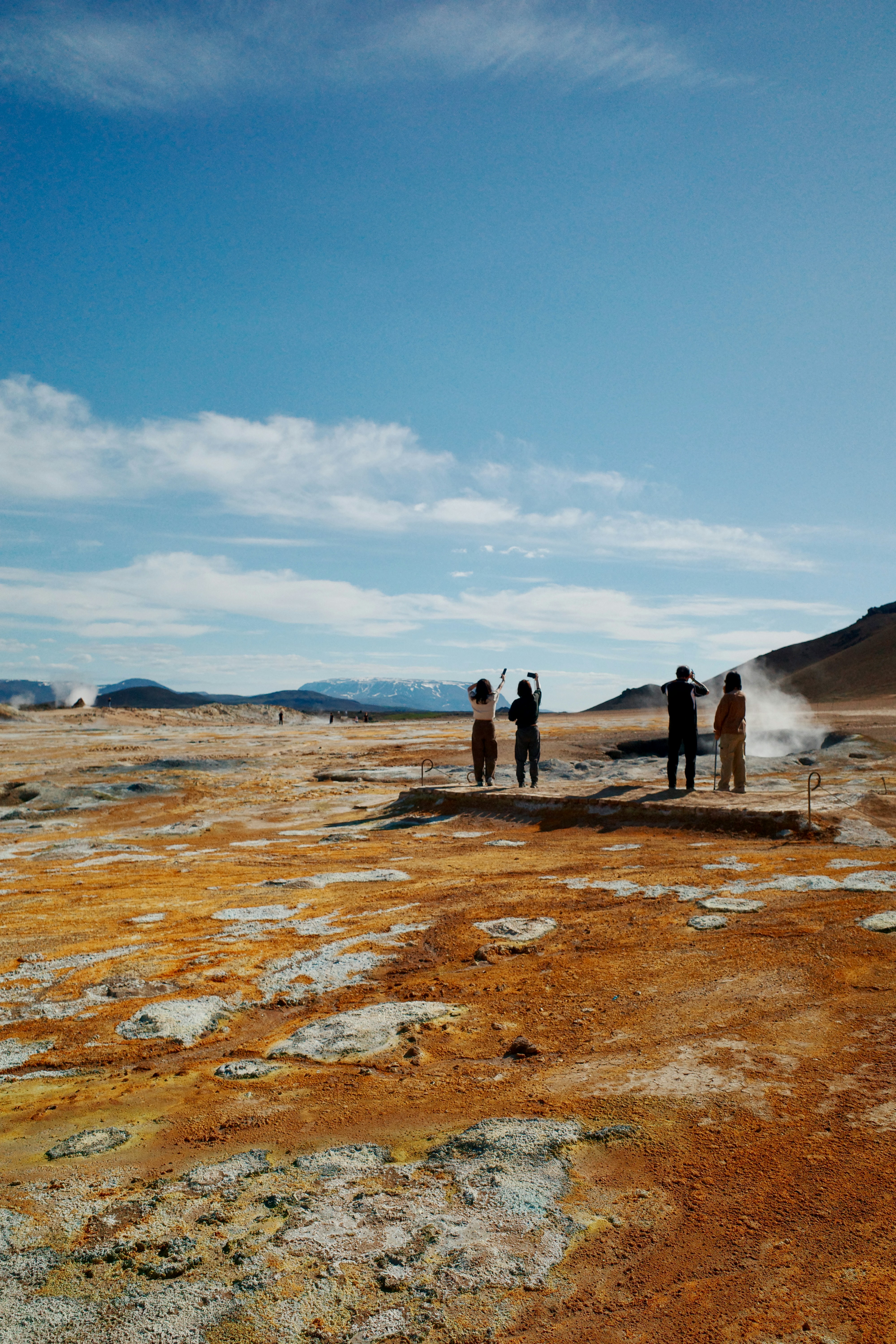 Desert Geyser Scene: silhouettes at the edge of mineral dust and steam