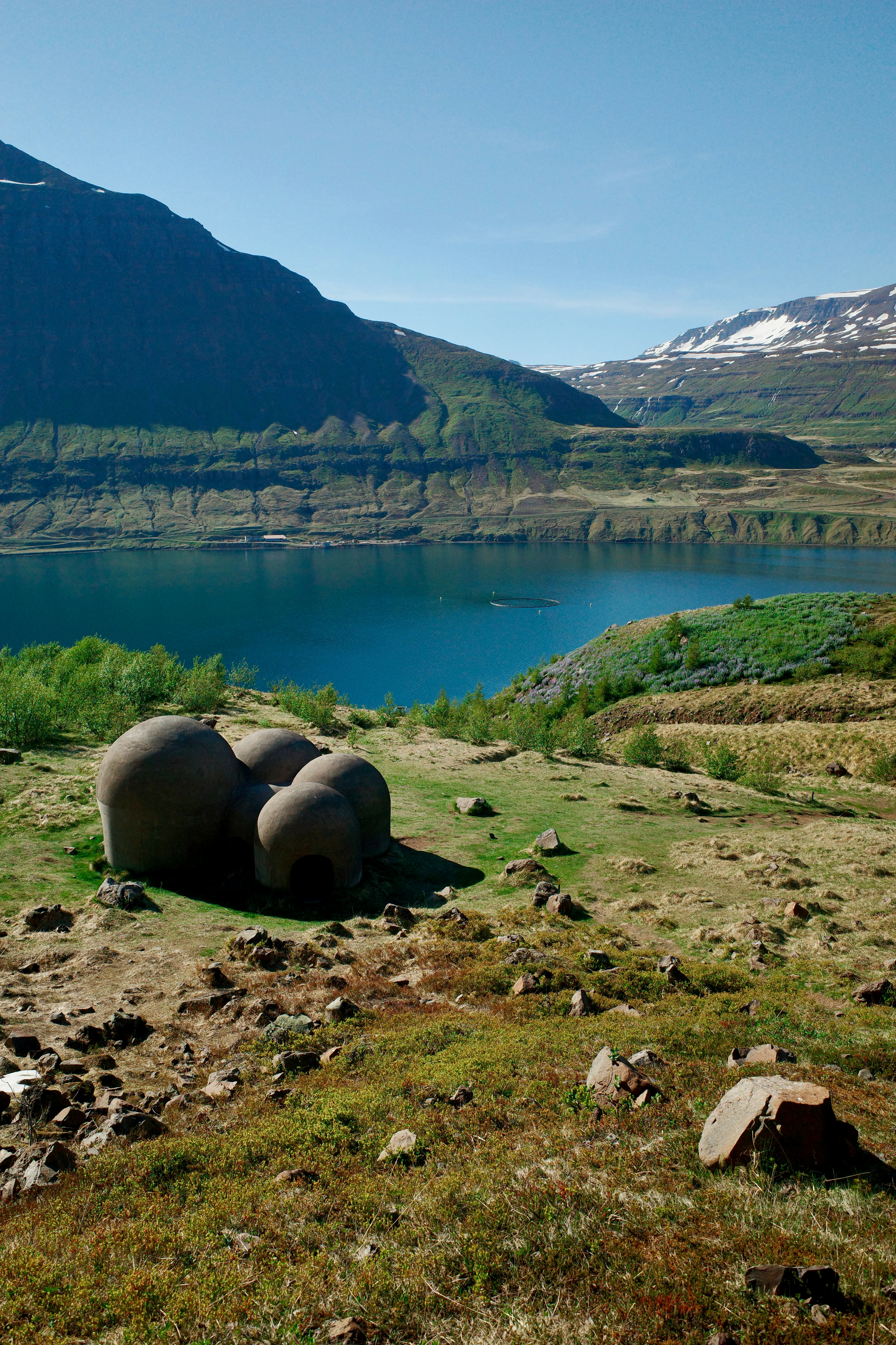 Stone Domes by the Fjord: A Quiet Landscape with Circular Huts