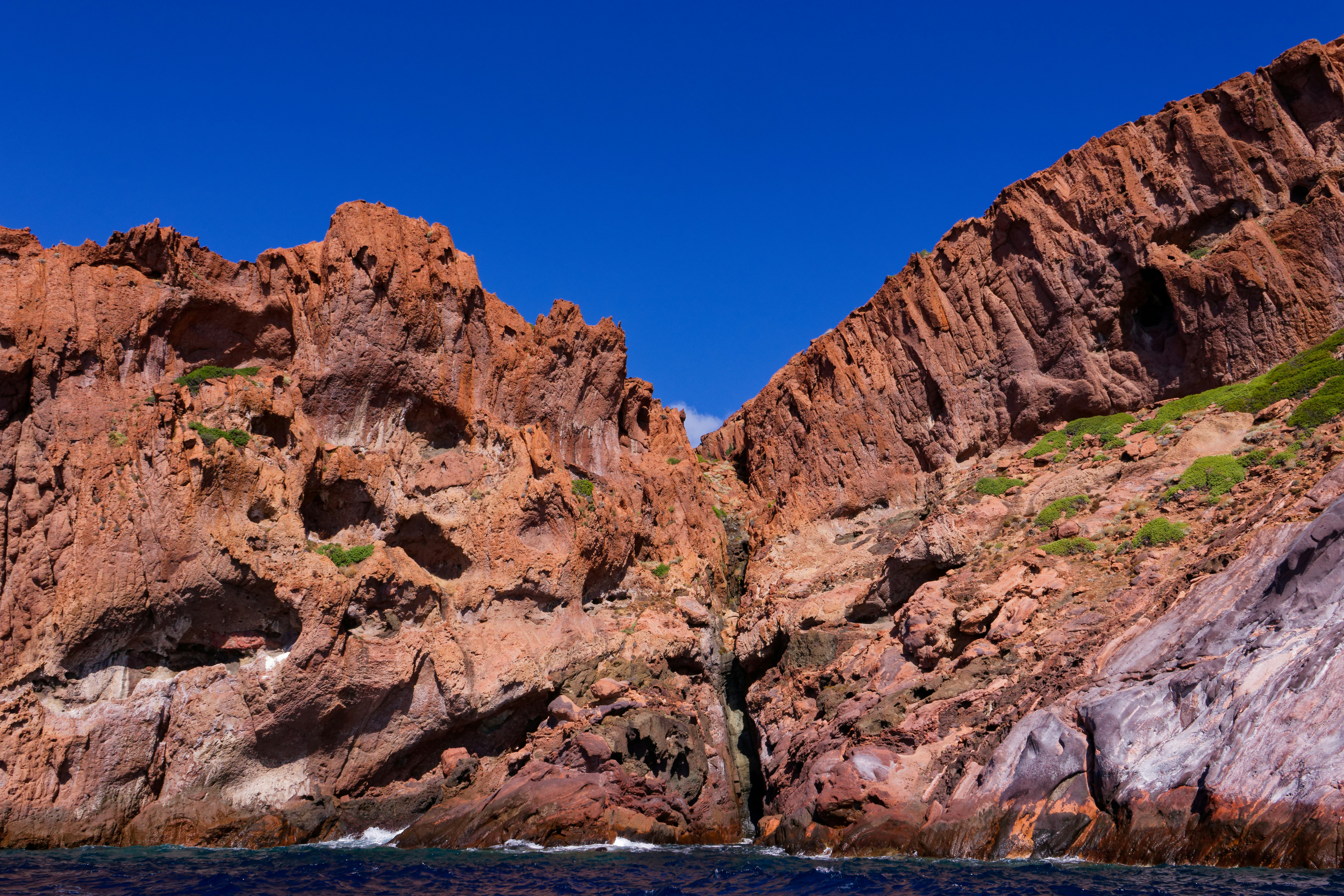 Crimson Cliffs Over Coastal Blue