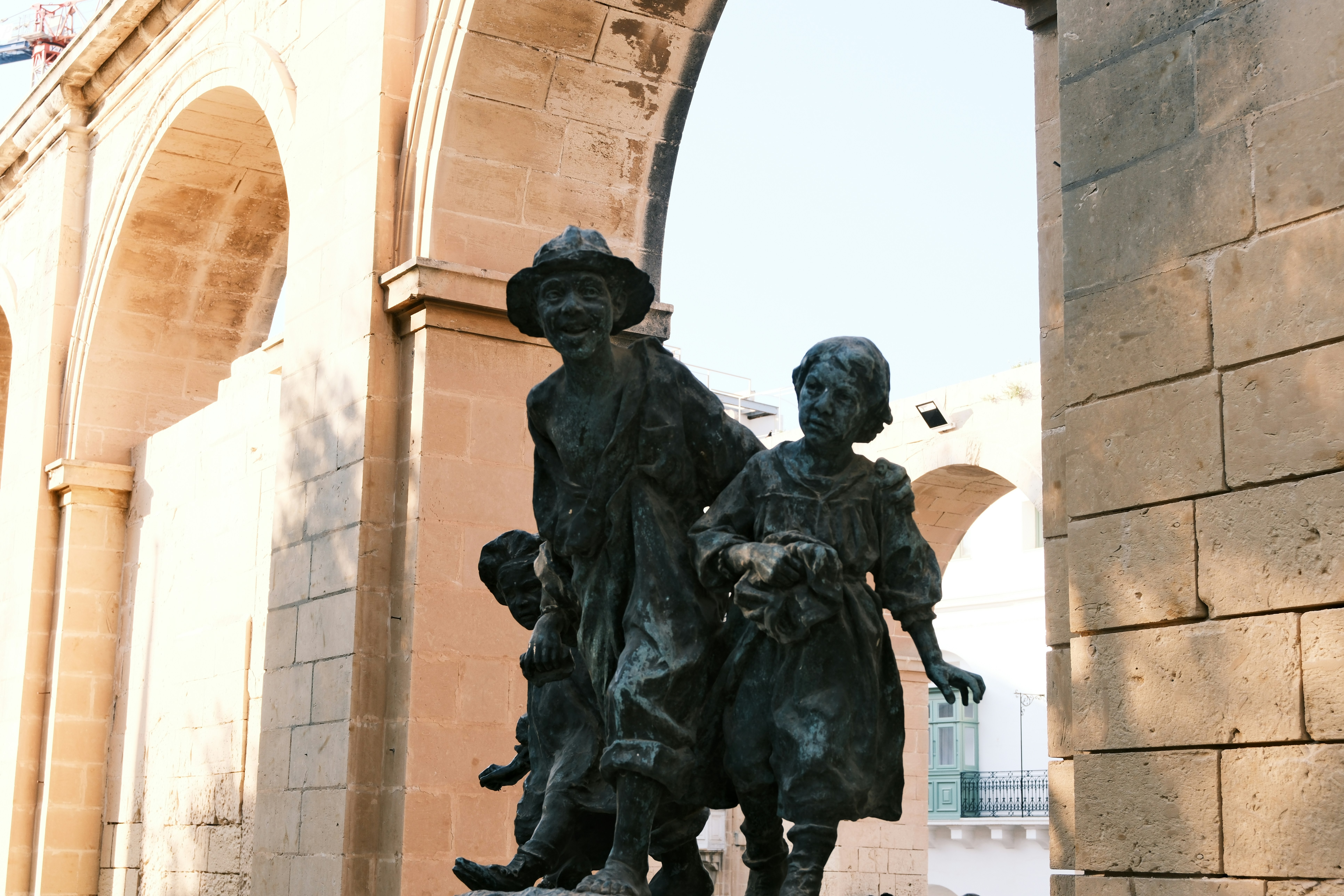 Stone Pedestal, Moving Figures: A Colonial Archway and a Trio of Children