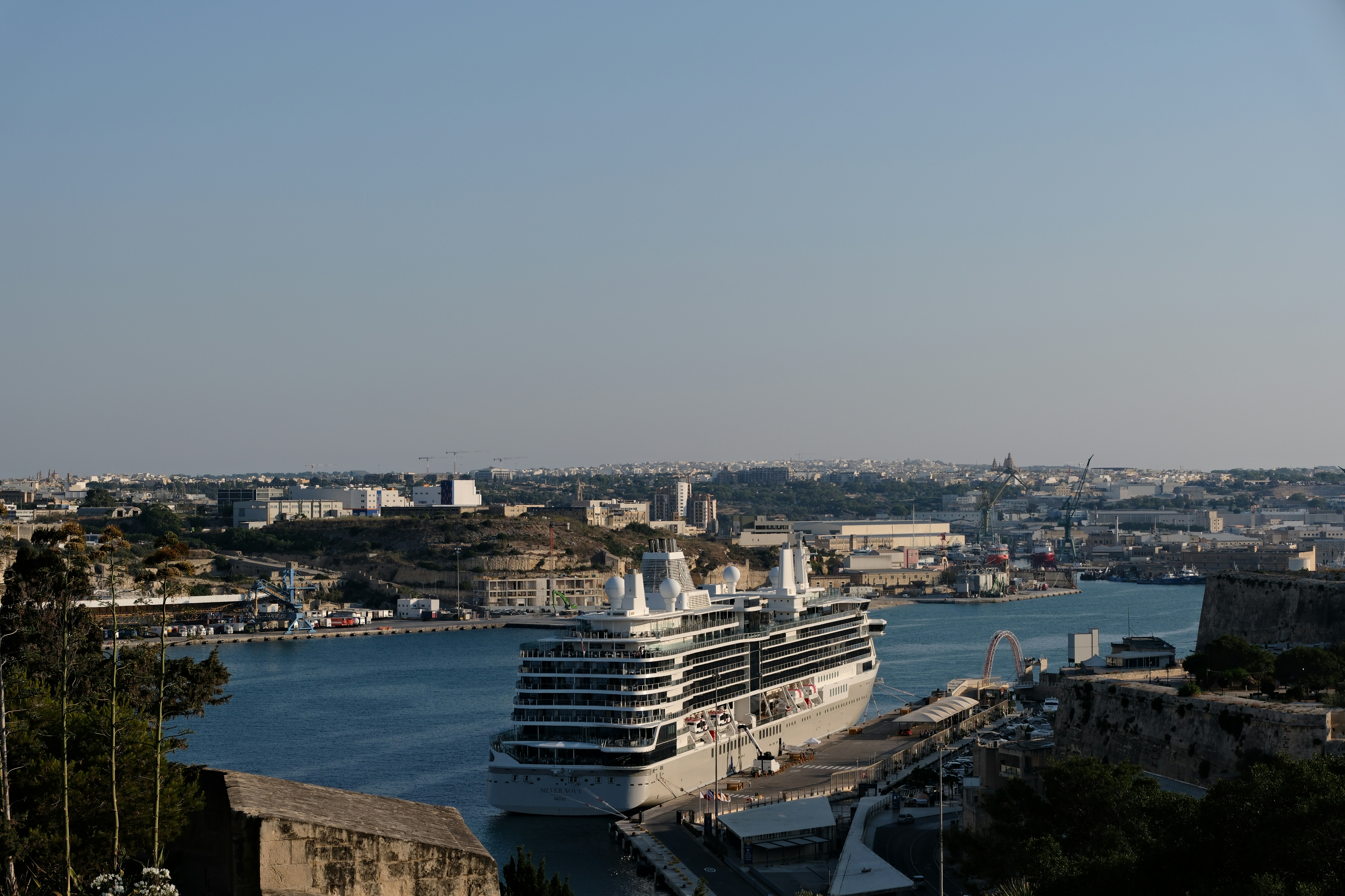 Harbor Beacon: A Grand Cruise Ship Docked Along the Coastal Bastion