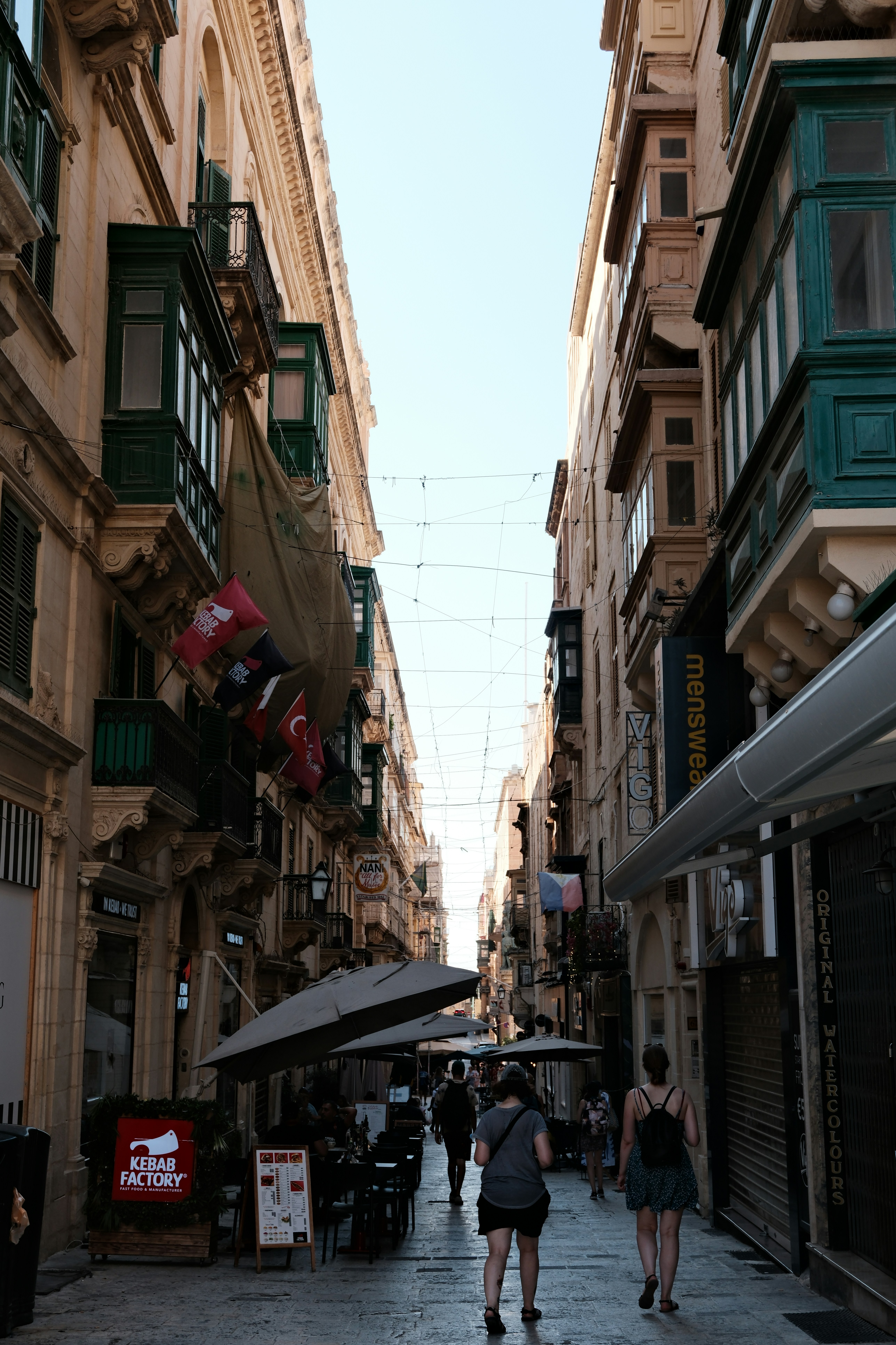 Narrow European Street Aglow with Quiet Social Pulse