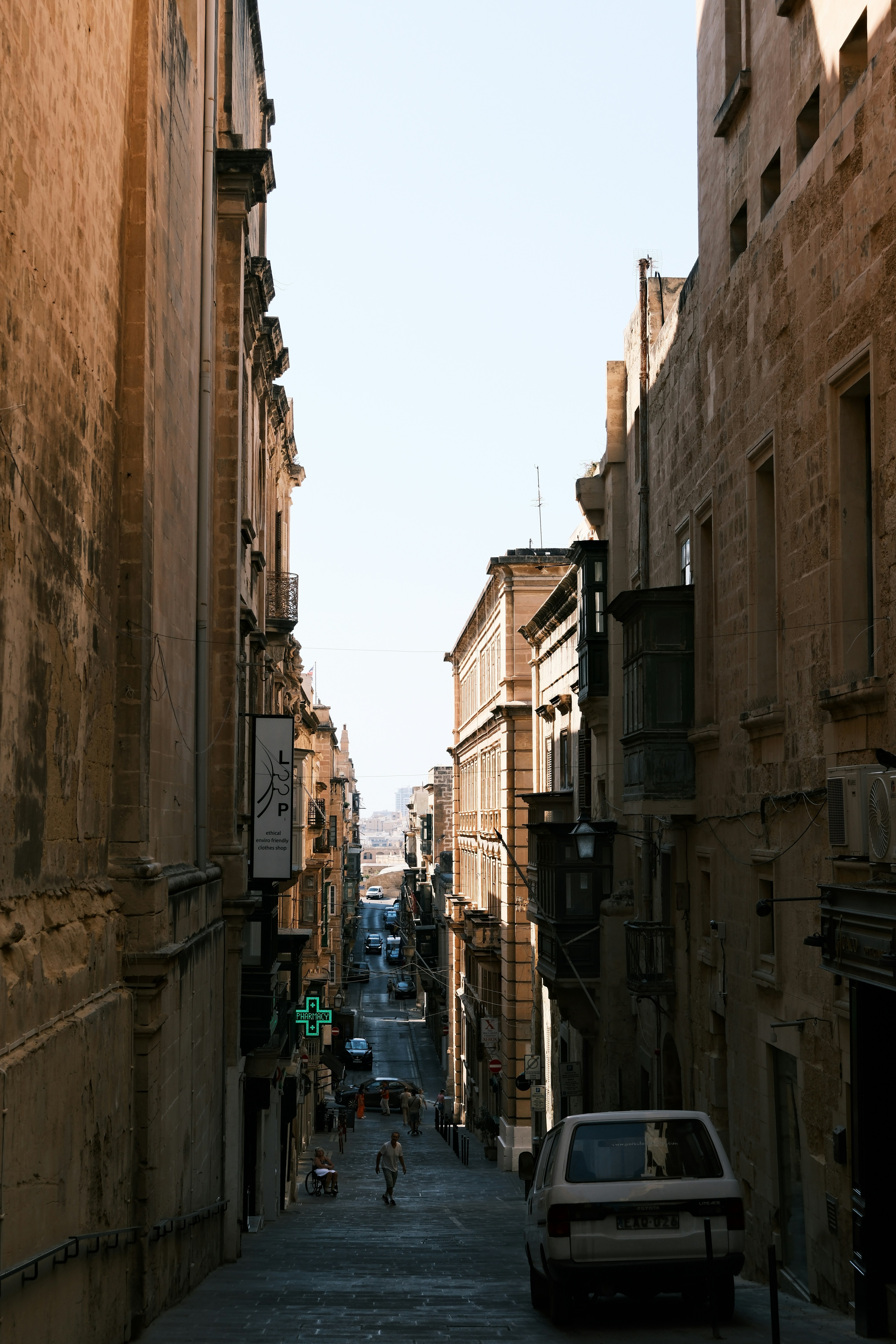 Gallery of Stone: A Sunlit Alley Between Historic Facades