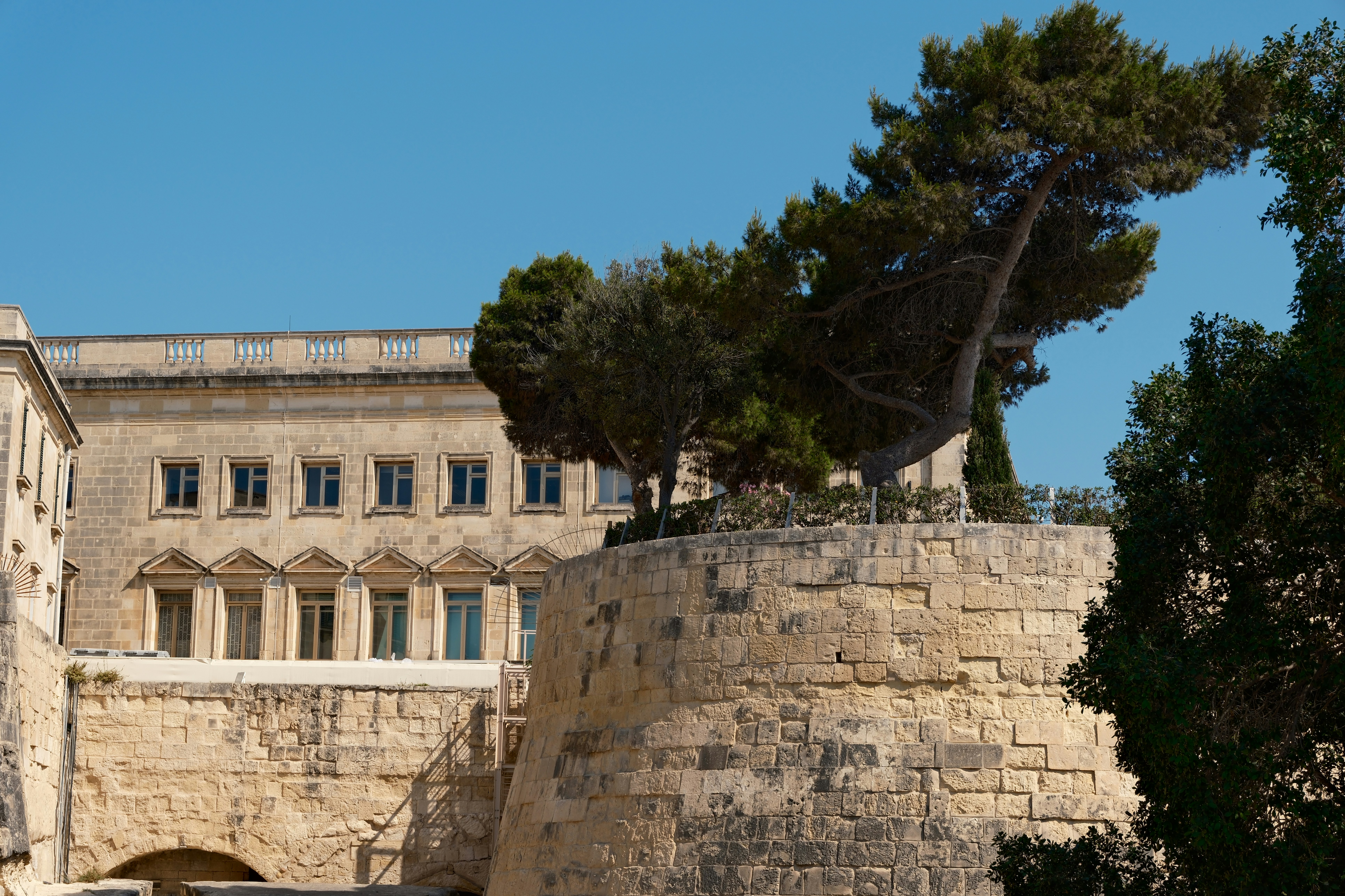 Stone Terrace and Tranquil Pine Over Looking a Historic Façade