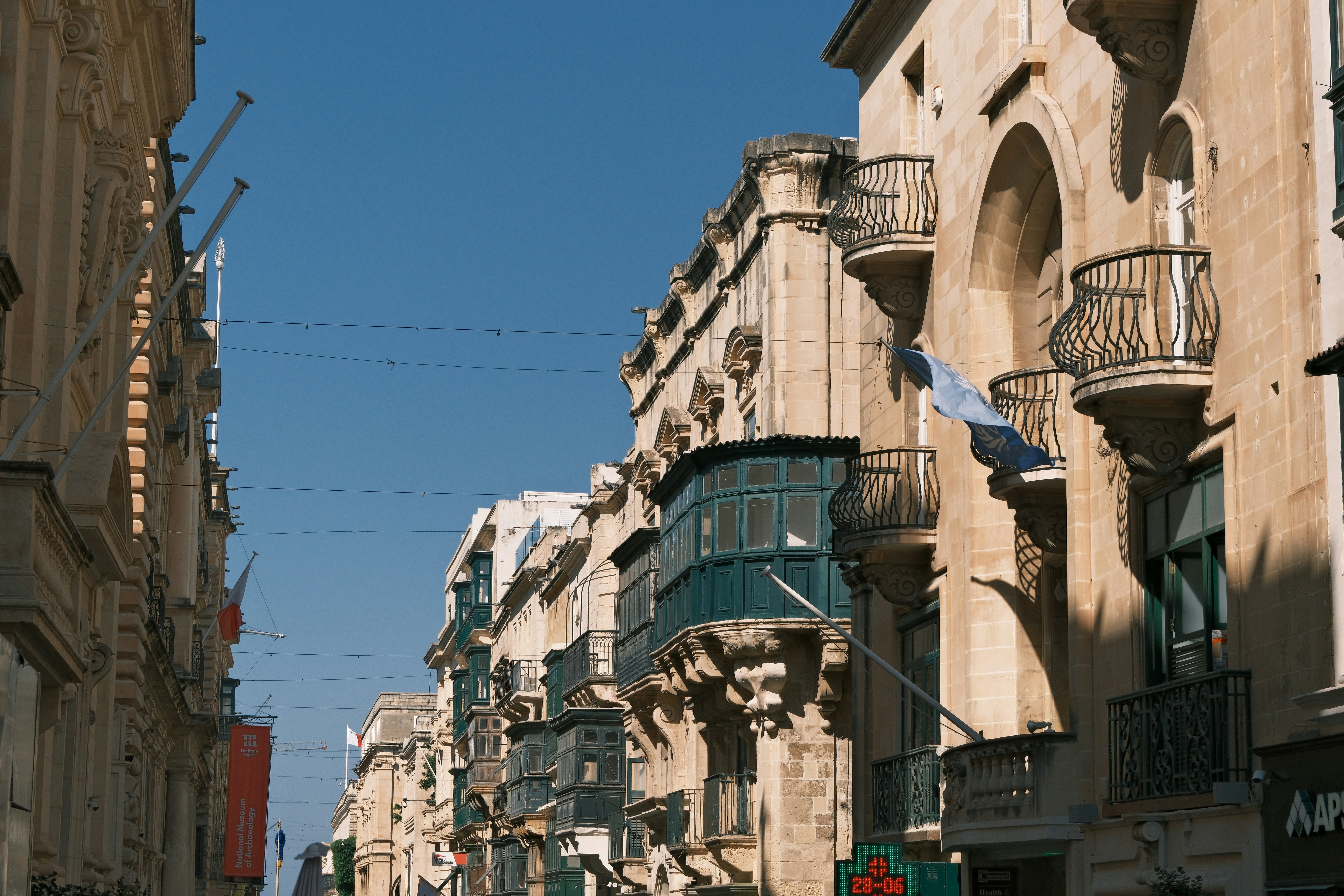 Sunlit Florentine Facades: A Narrow Street Alive with Balconies