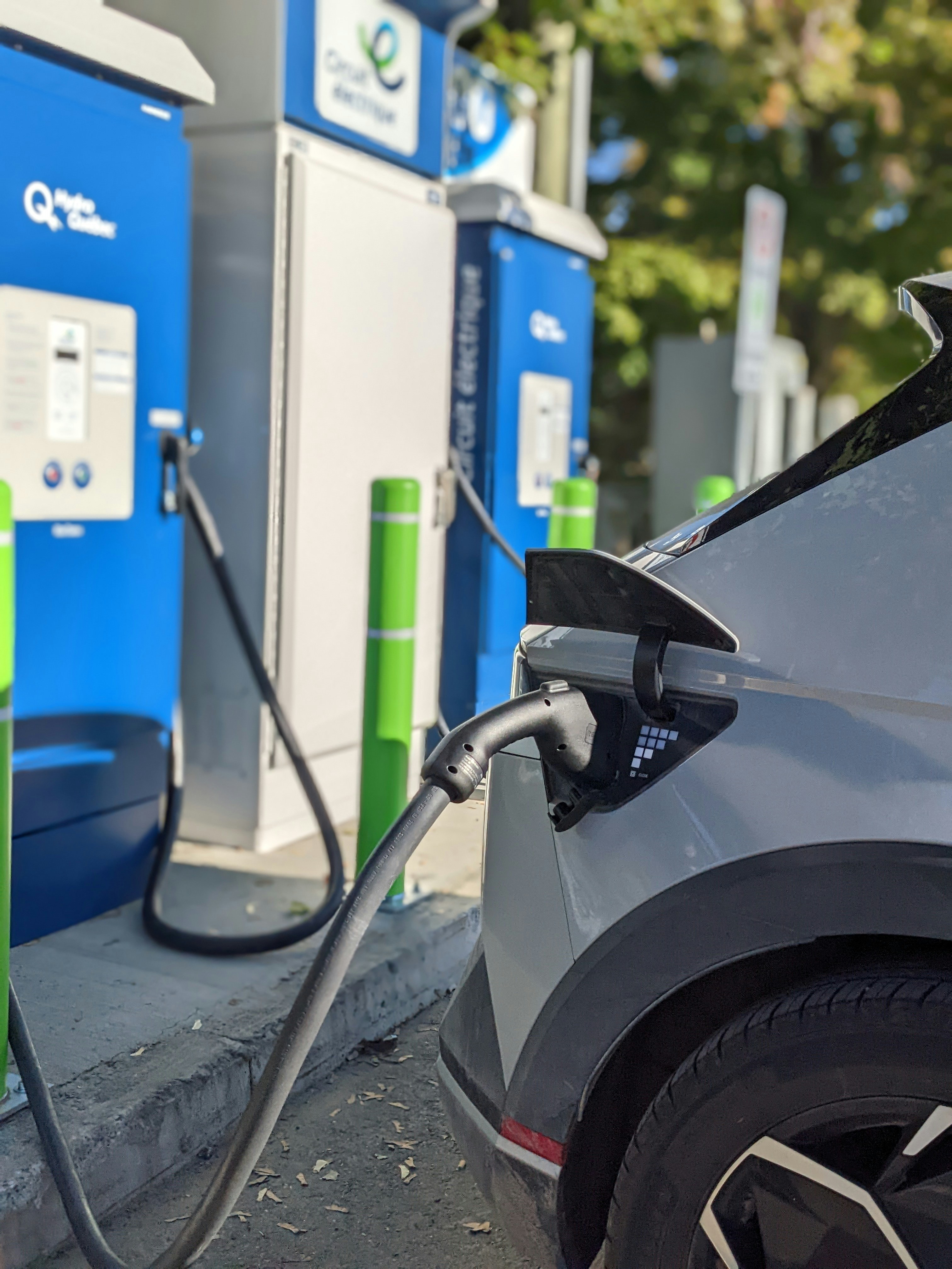 Electric car charging at a busy station